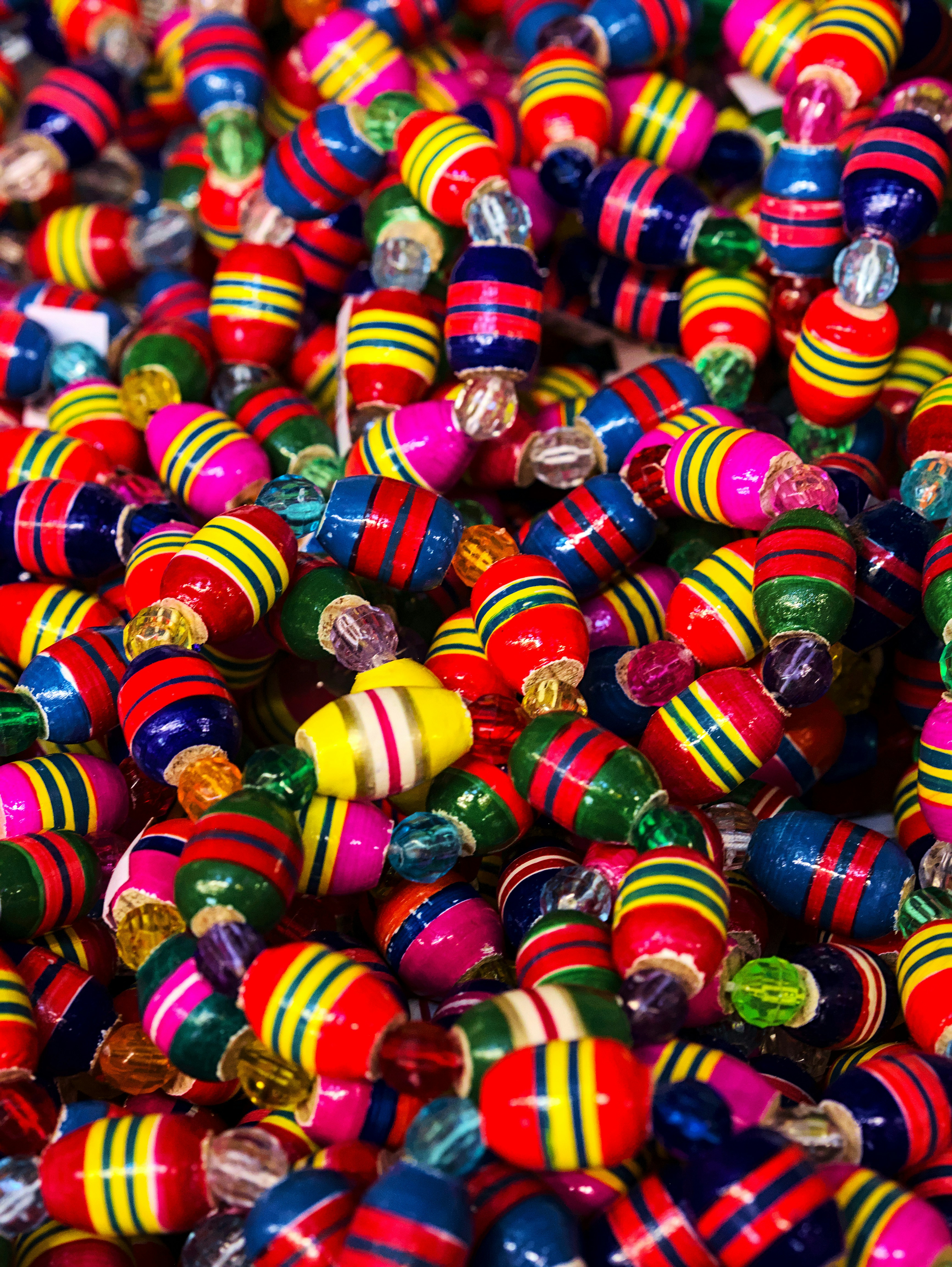 A pile of colorful beads sitting on top of a table photo – Free ...