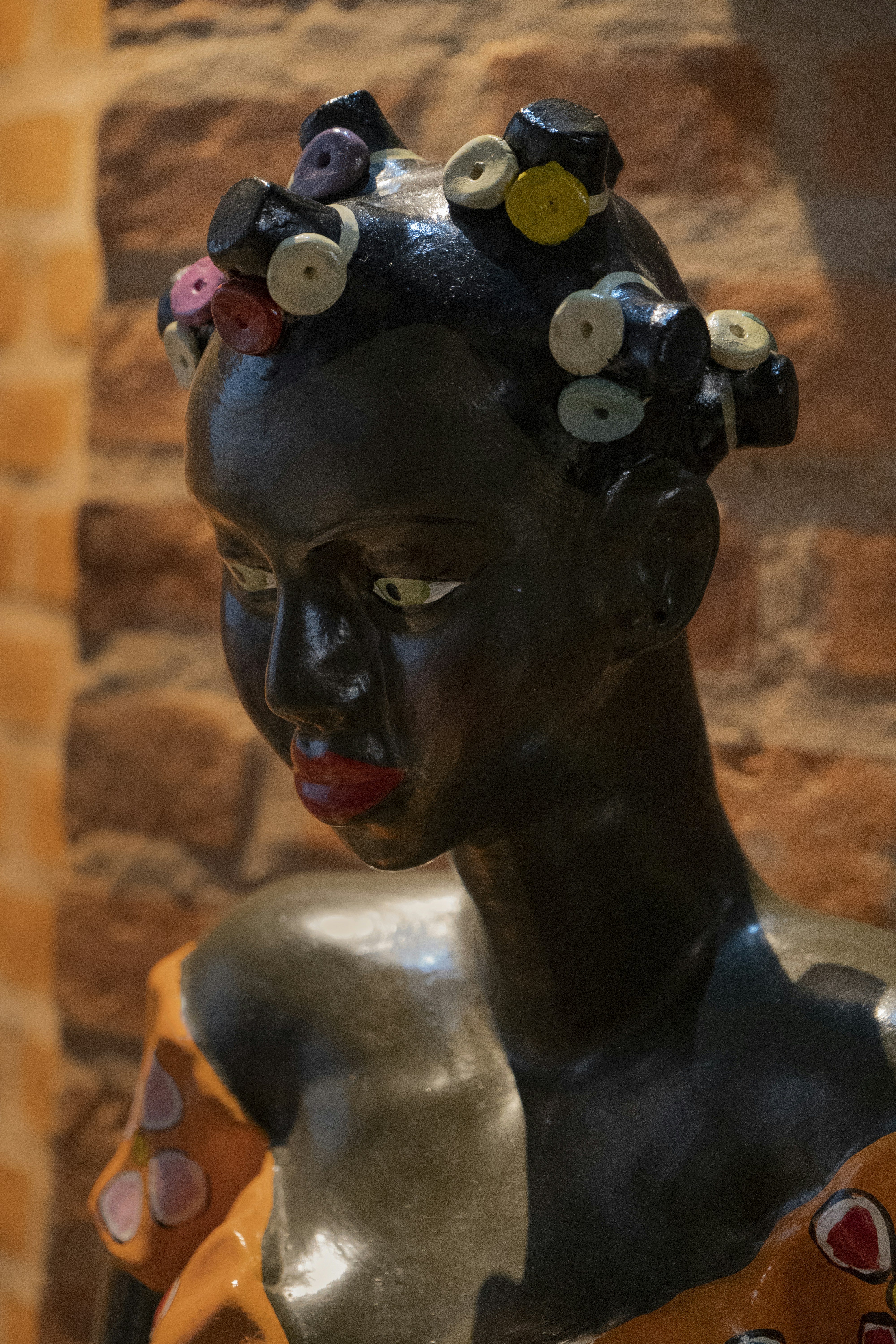 A statue of a woman with buttons in her hair photo – Free Man Image on ...