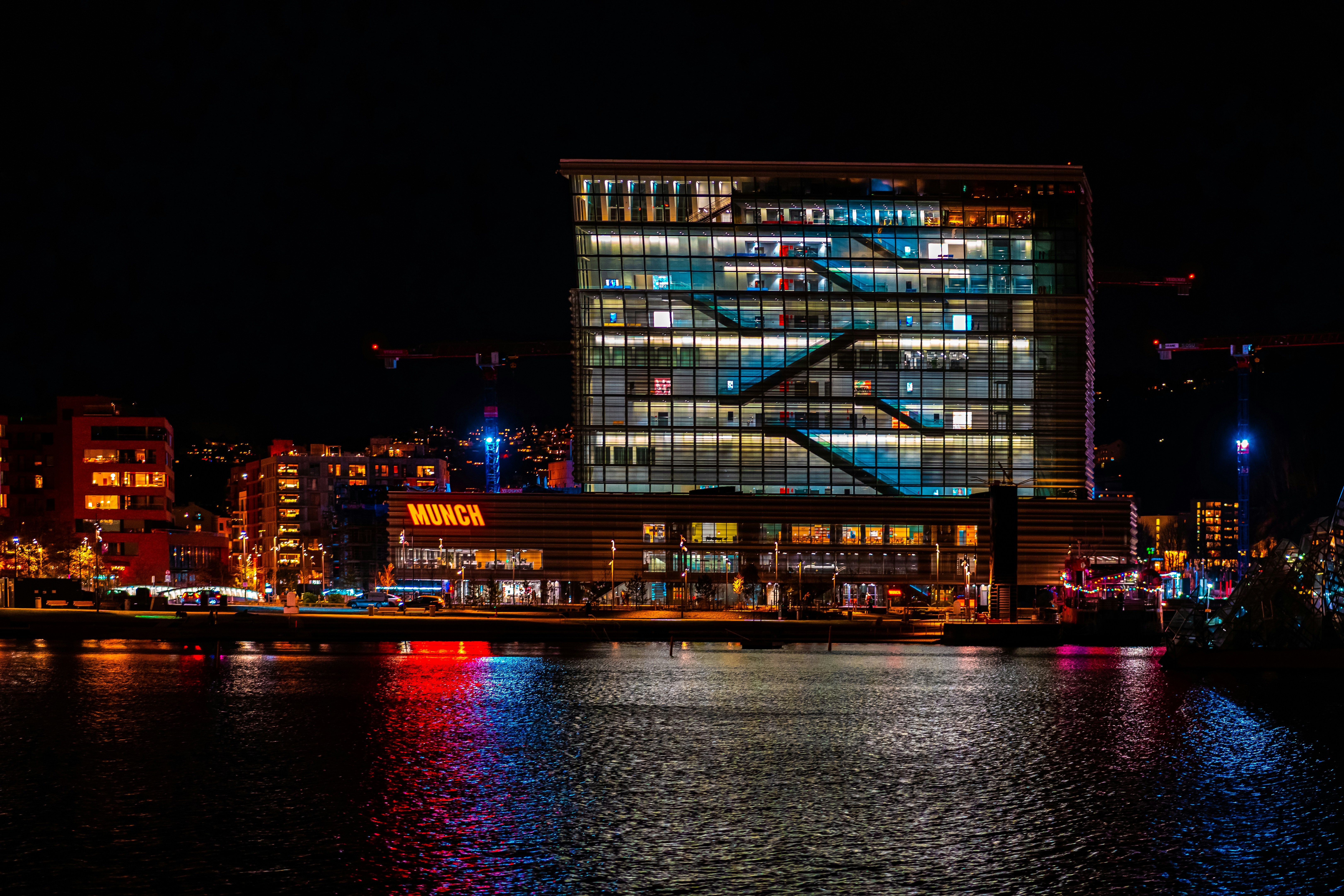 Neon Zigzag over the Waterfront: a Glass-Faced Tower at Night
