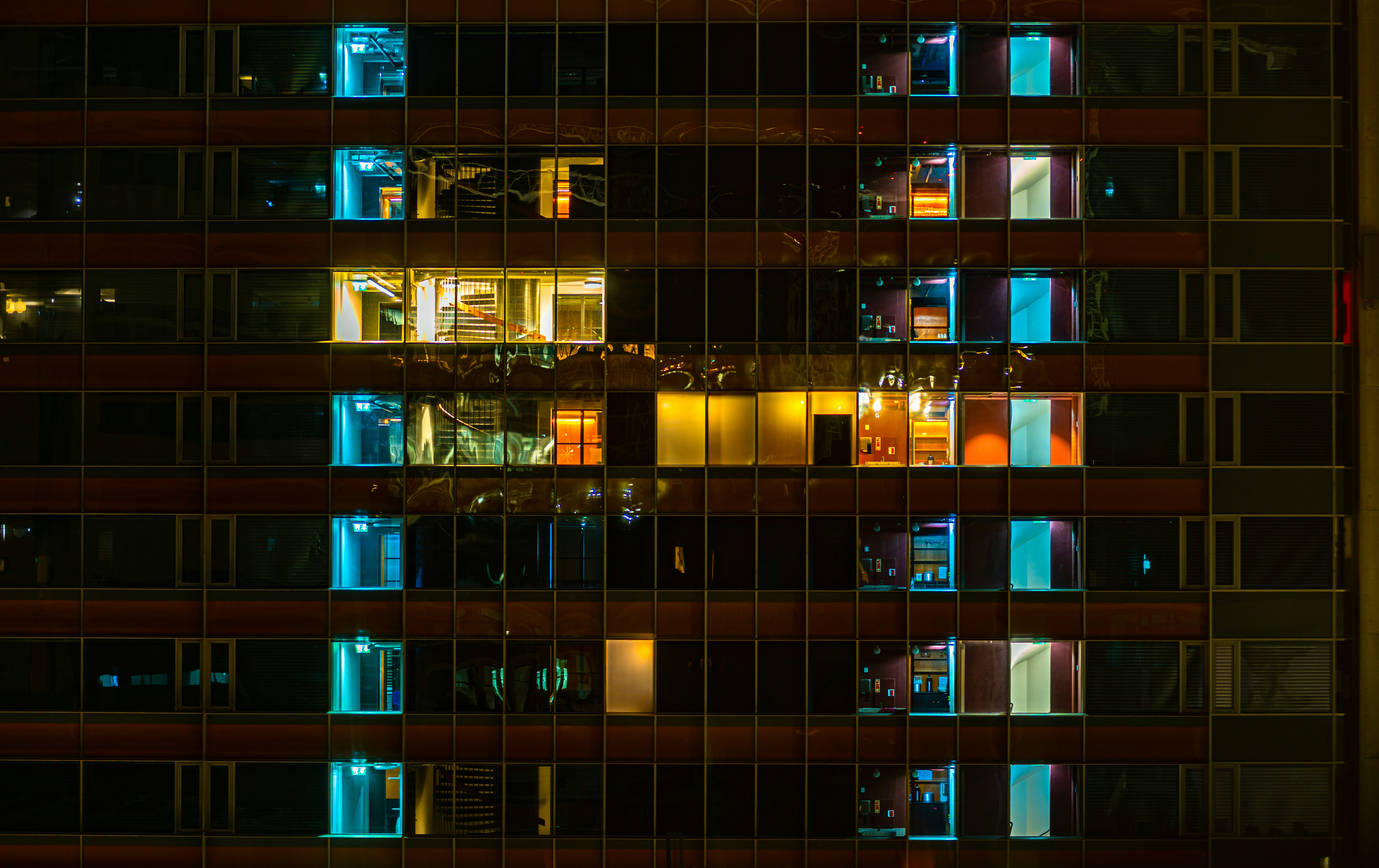 A tall building with lots of windows lit up at night photo – Free Oslo ...