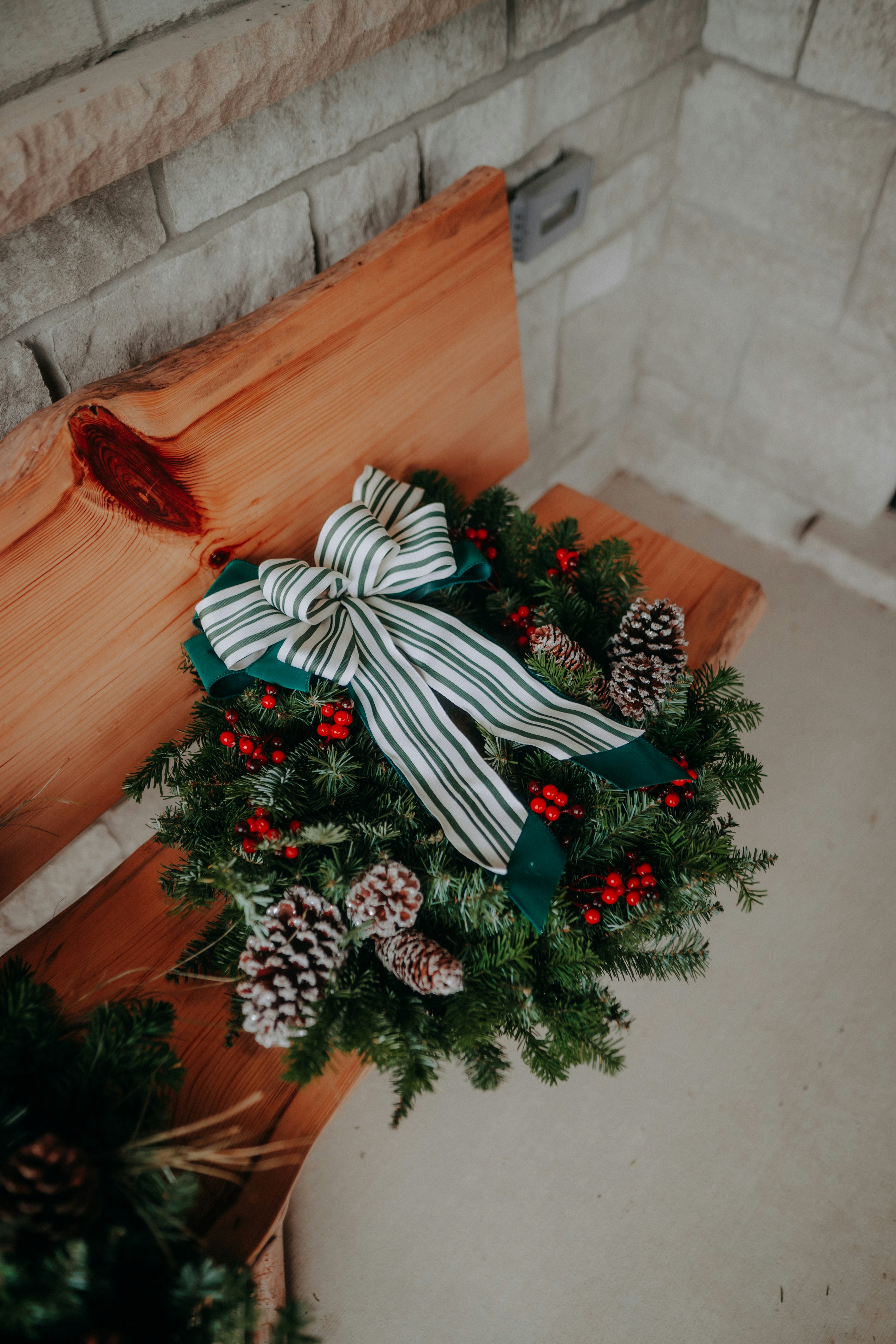 A christmas wreath on top of a wooden bench photo – Free Christmas ...