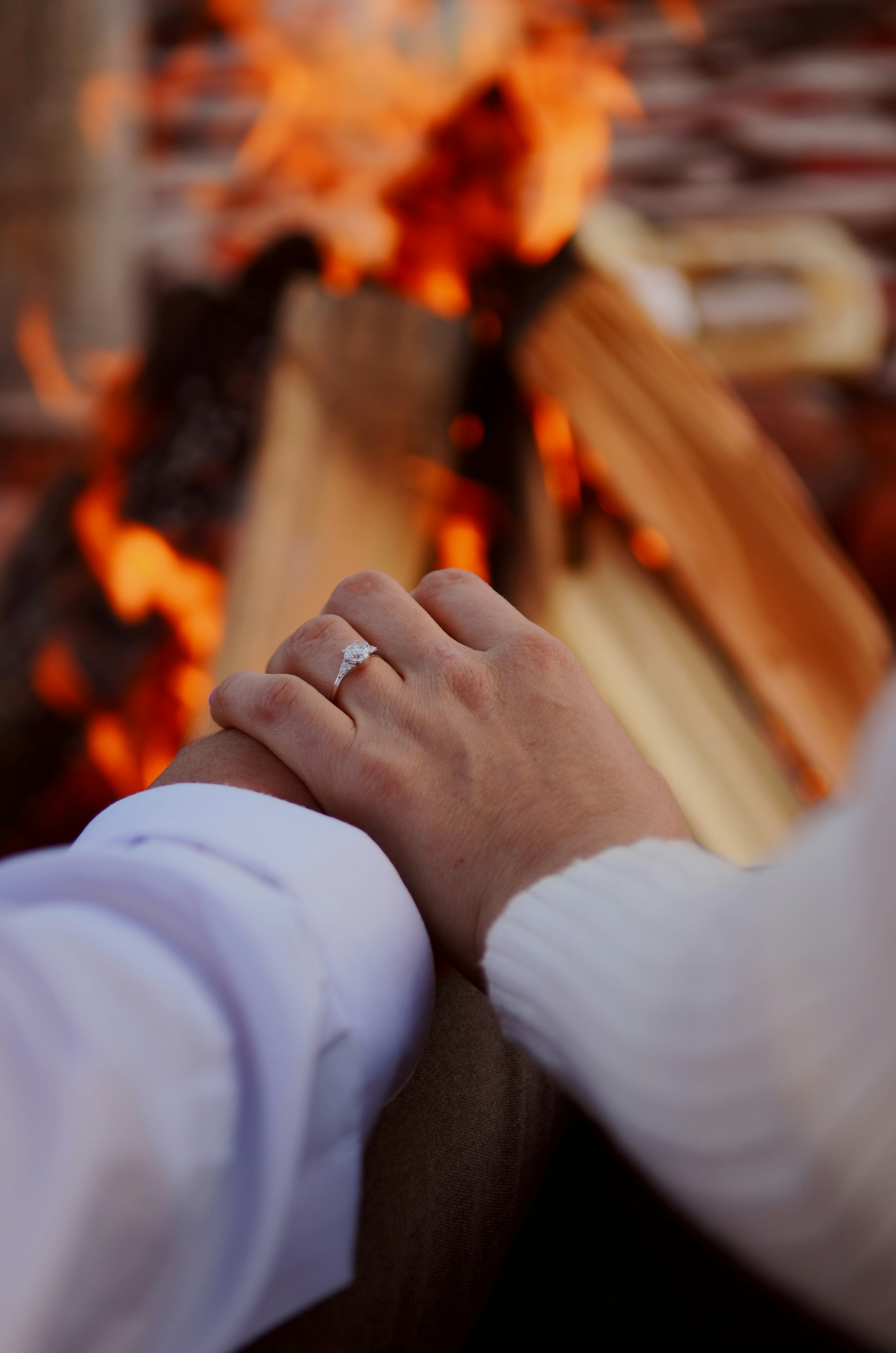 A close up of two people holding hands near a fire photo – Free Fire ...