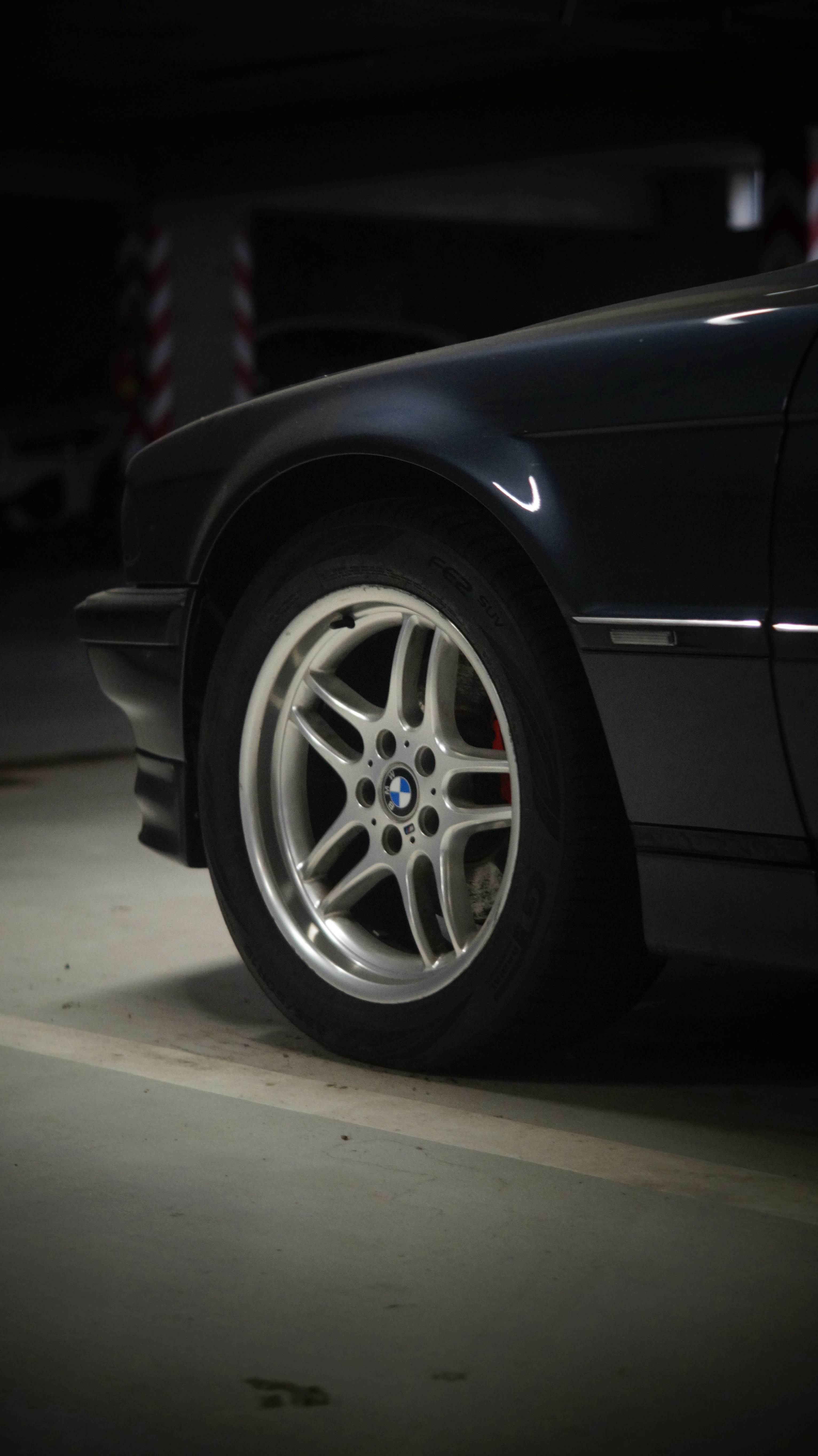 A black car parked in a parking garage photo – Free Poprad Image on ...