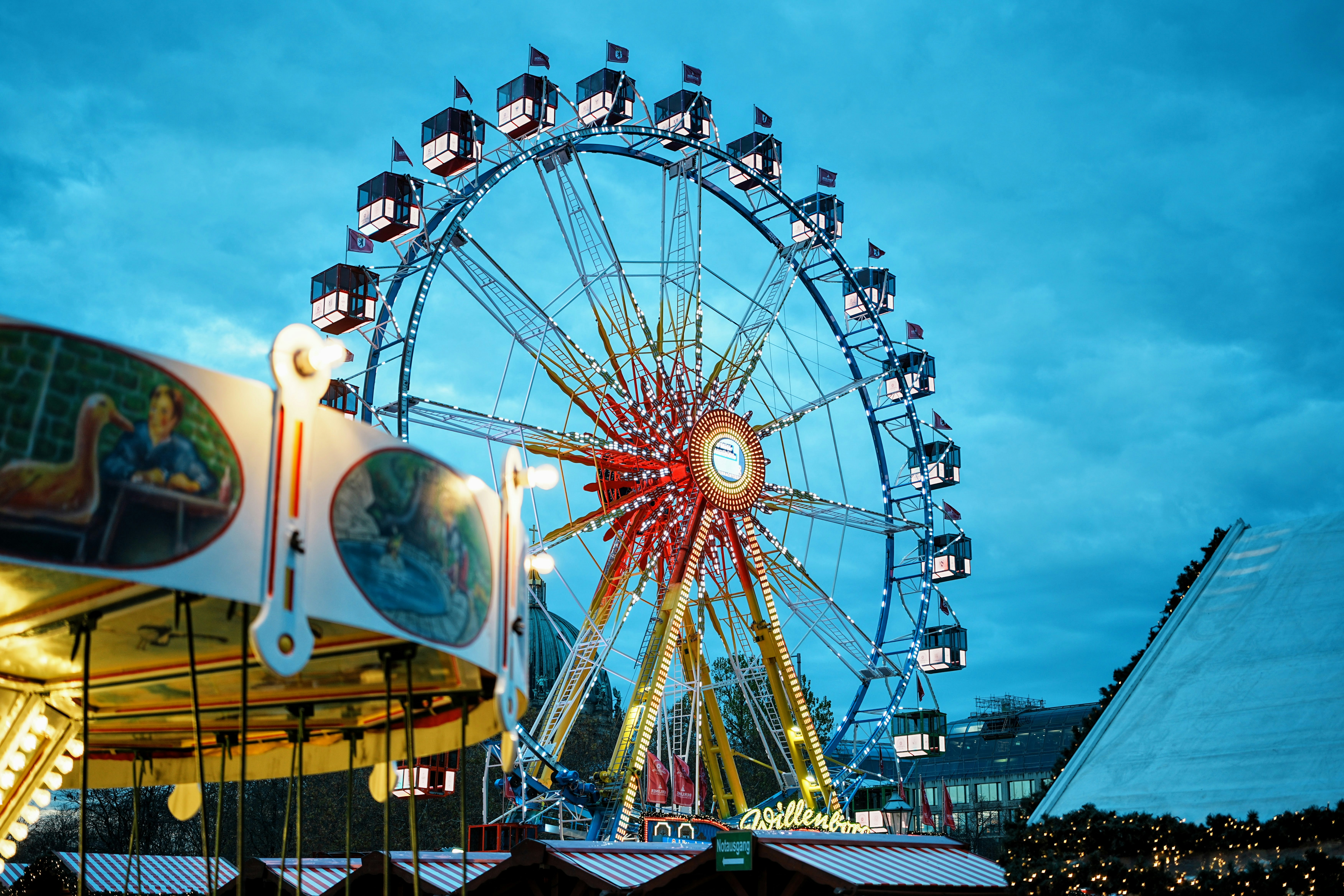 Electric Blue Twilight: Ferris Wheel Halo Over a Neon Carnival