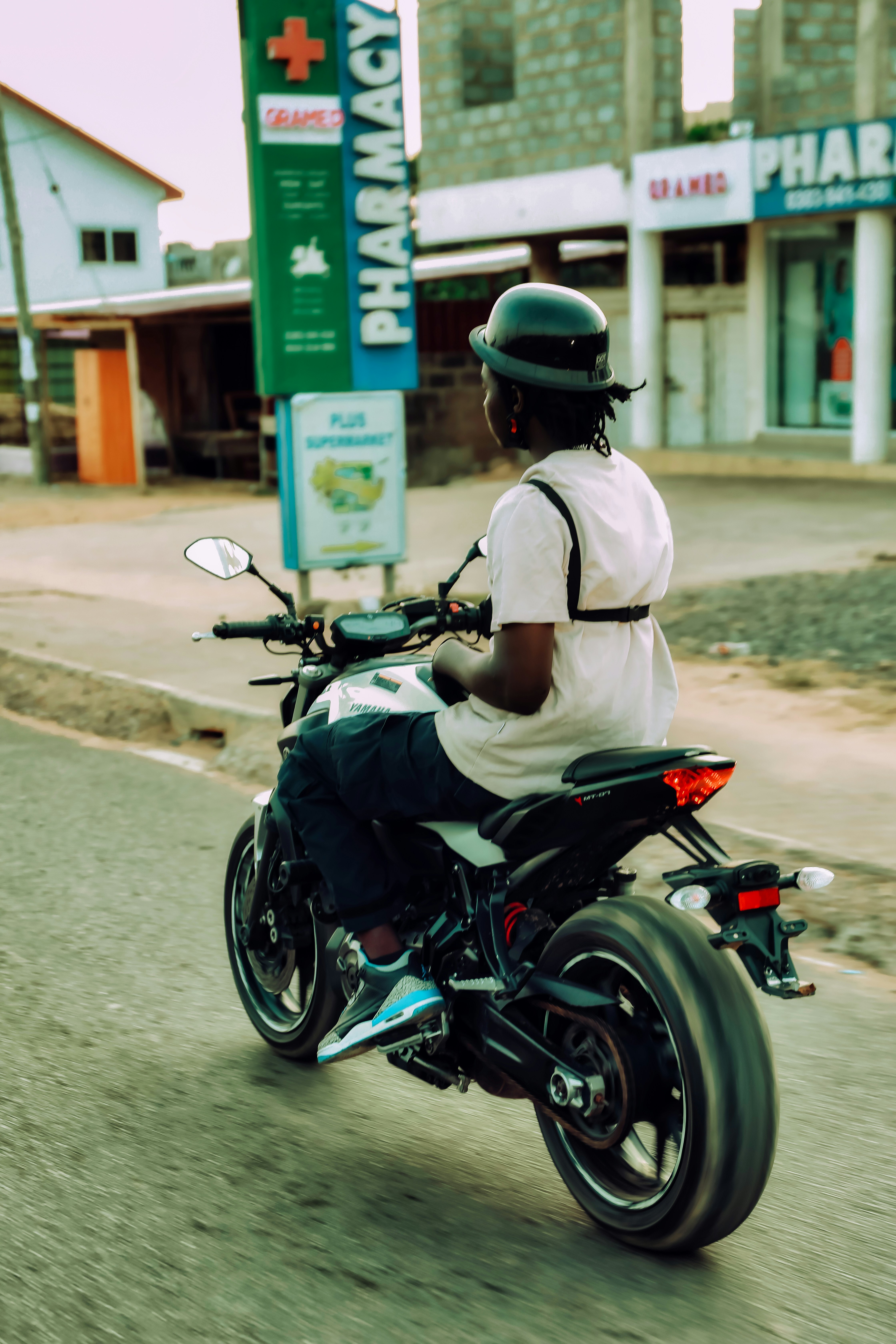 Rear-View Ride through a Pharmacy-Fronted Street