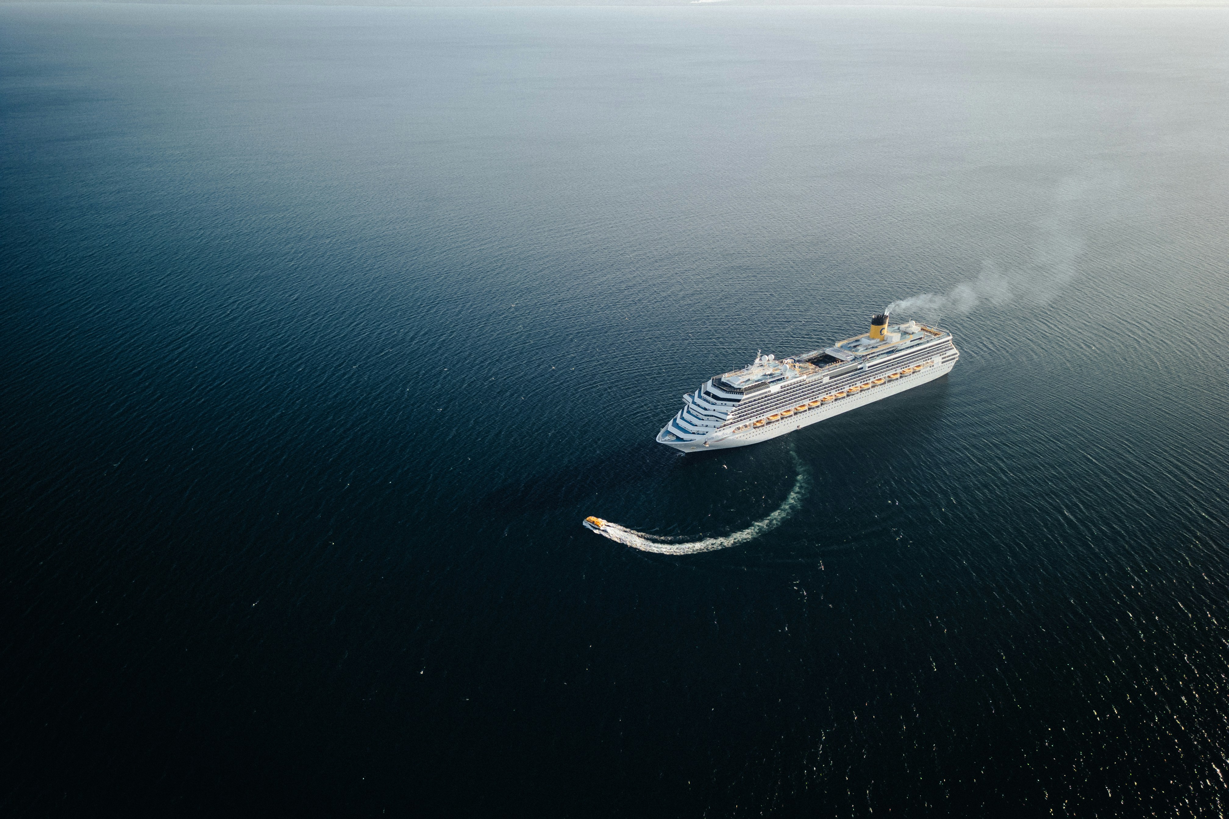 A large white boat floating on top of a body of water