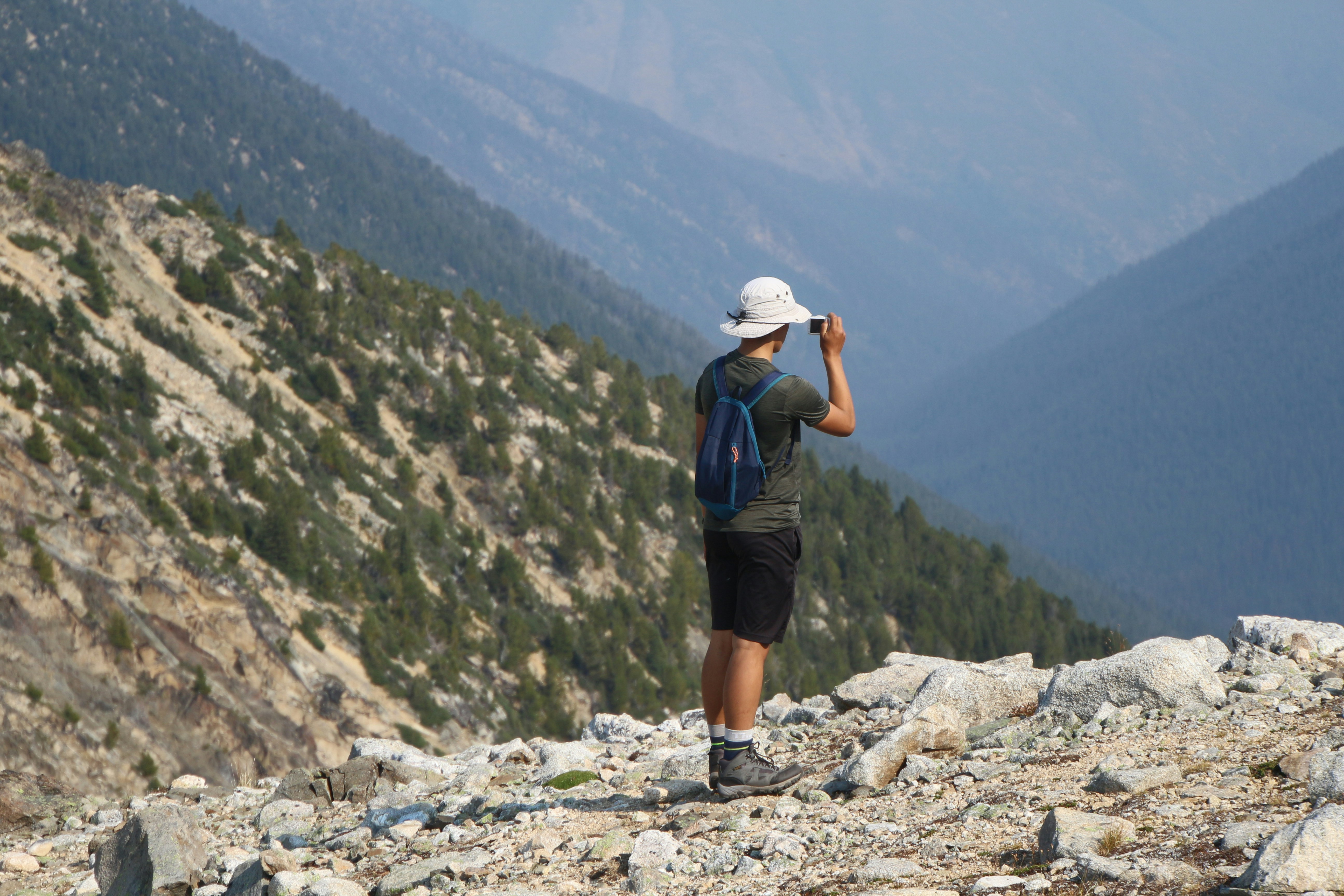A man standing on top of a rocky mountain