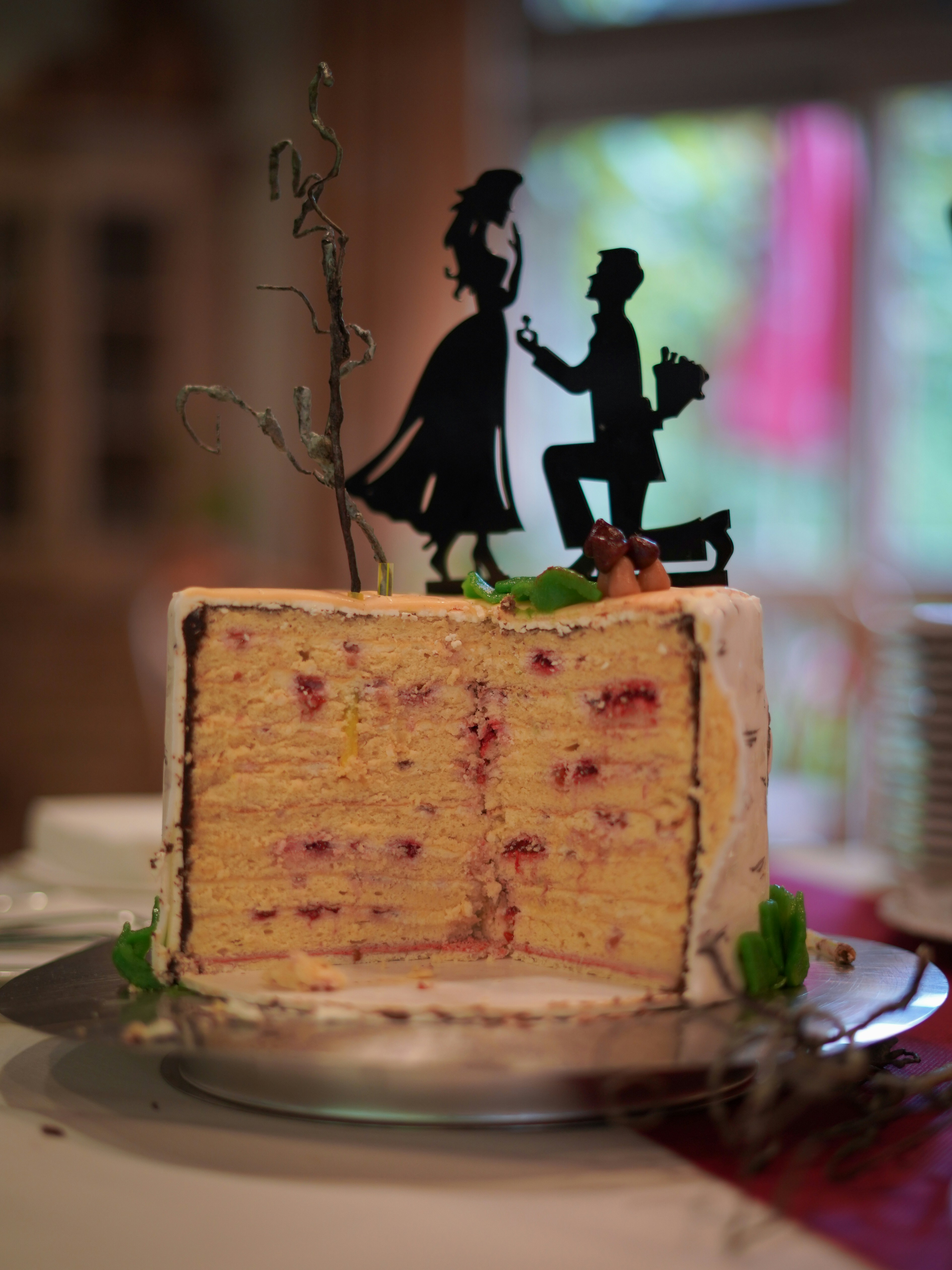 A cake with a silhouette of a man and woman on top of it