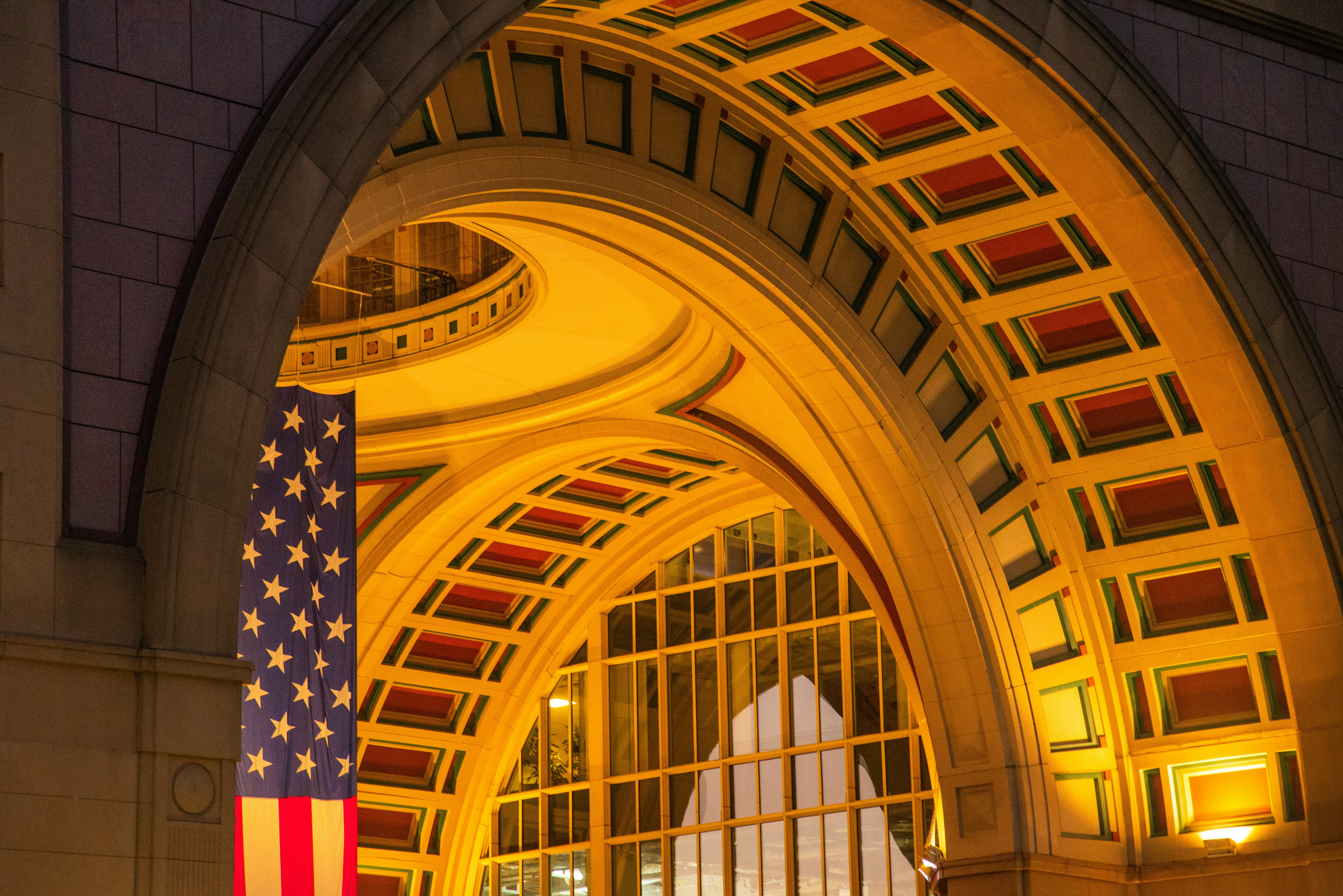 A large american flag hanging from the ceiling of a building photo ...