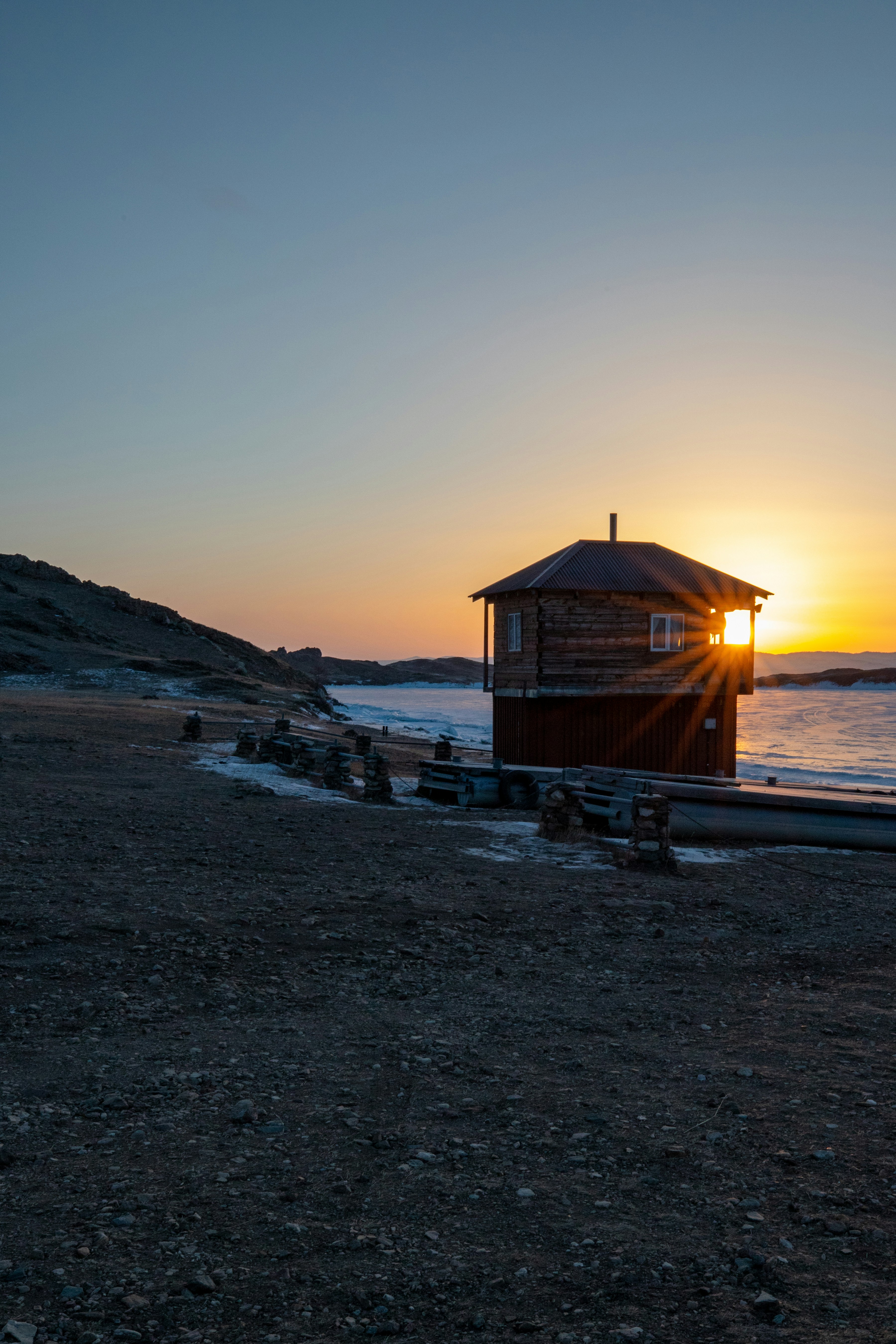 Sunlit Sentinel by the Sea: A Coastal Cabin at Dusk