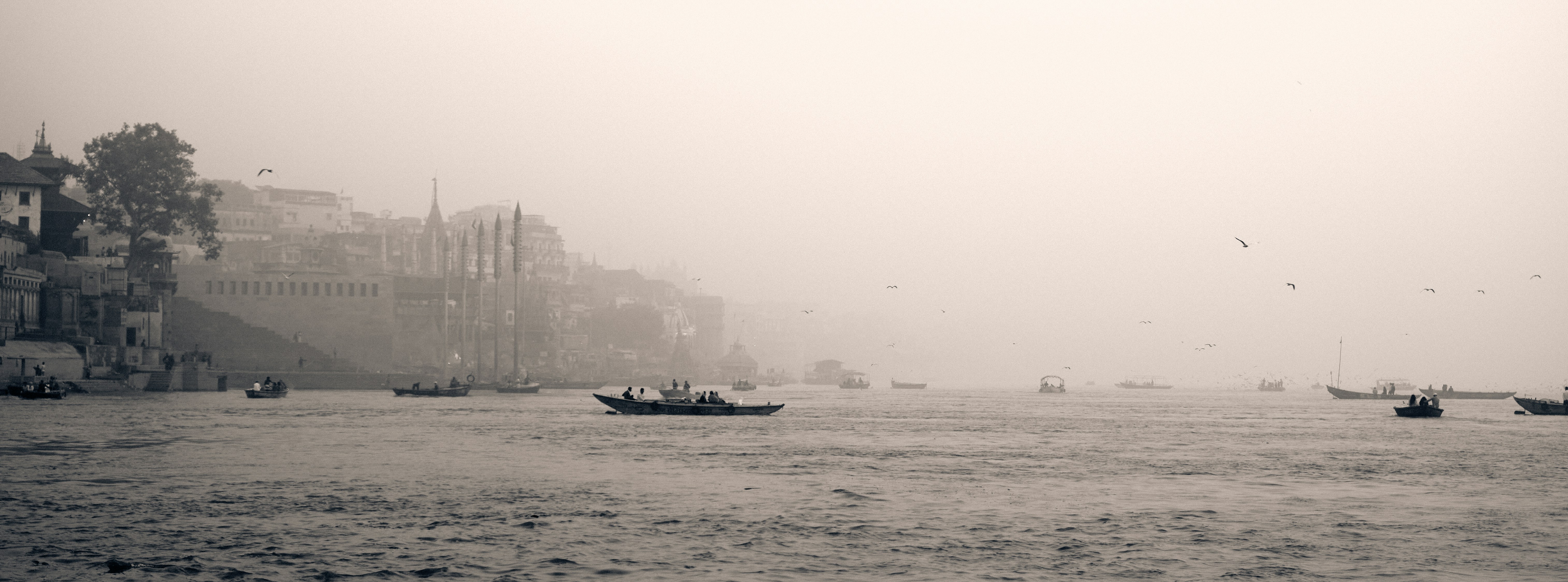 A group of boats floating on top of a lake photo – Free Varanasi Image ...