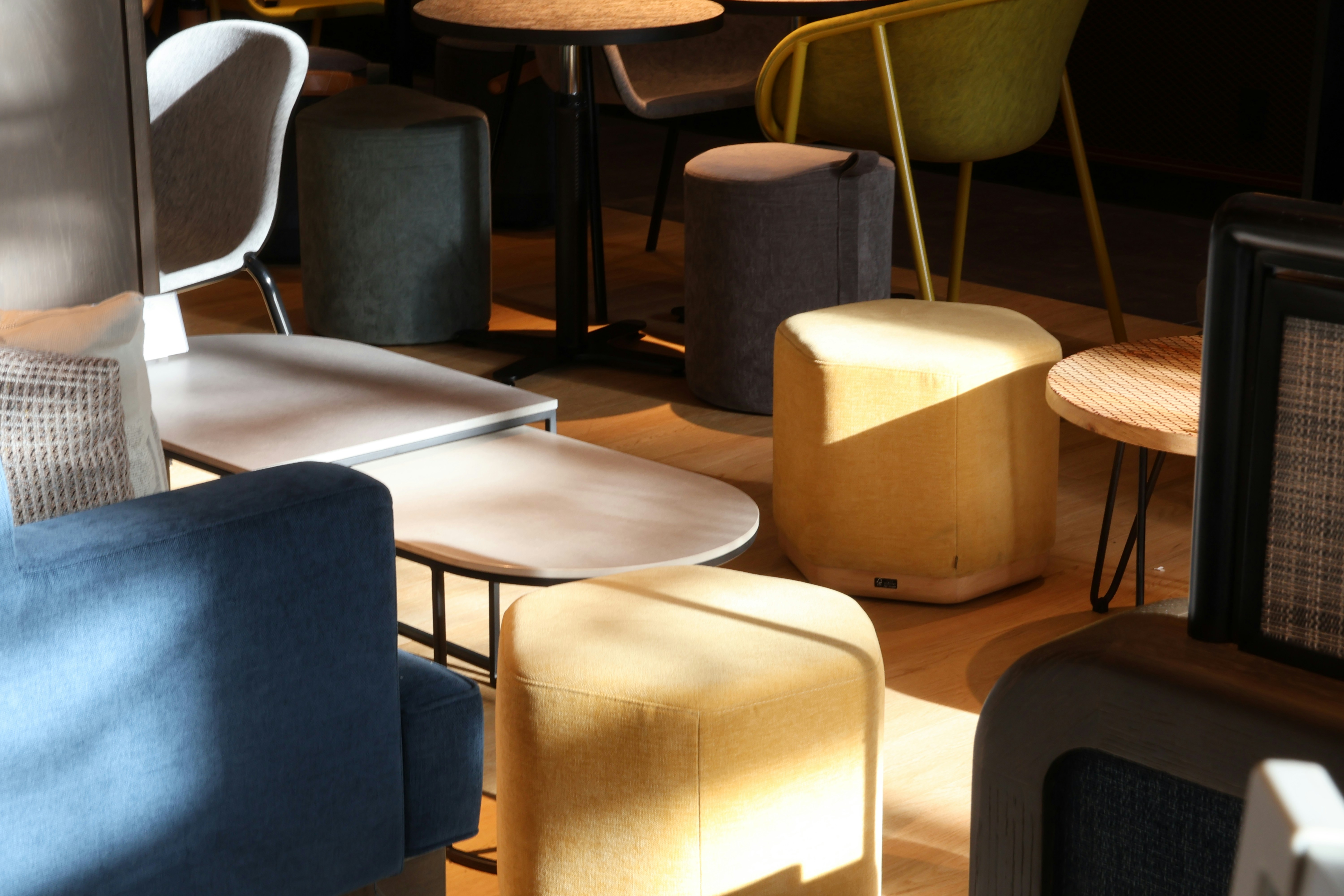 A room filled with lots of different colored chairs photo – Free ...