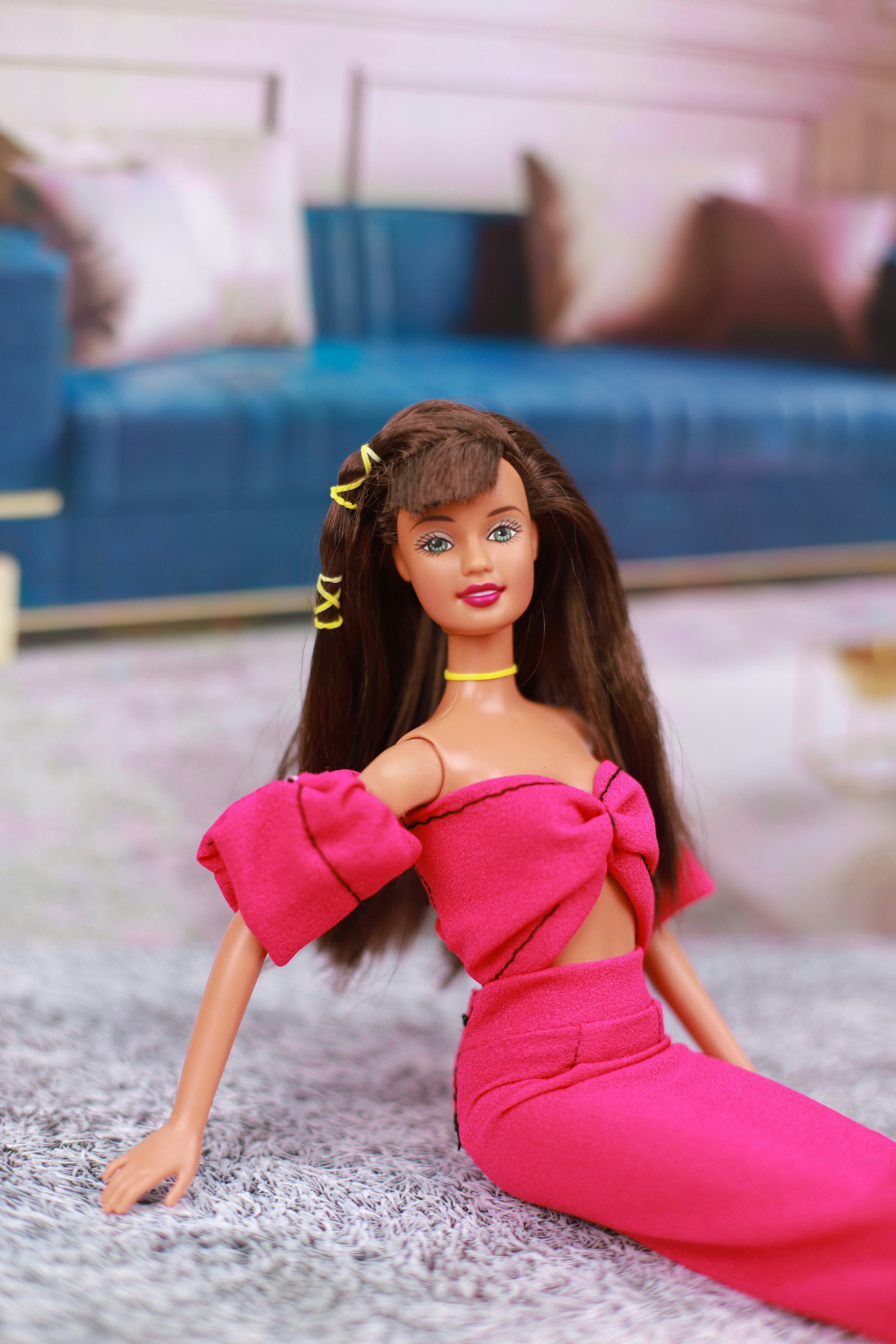 A barbie doll sitting on the floor in a living room photo – Free Doll ...