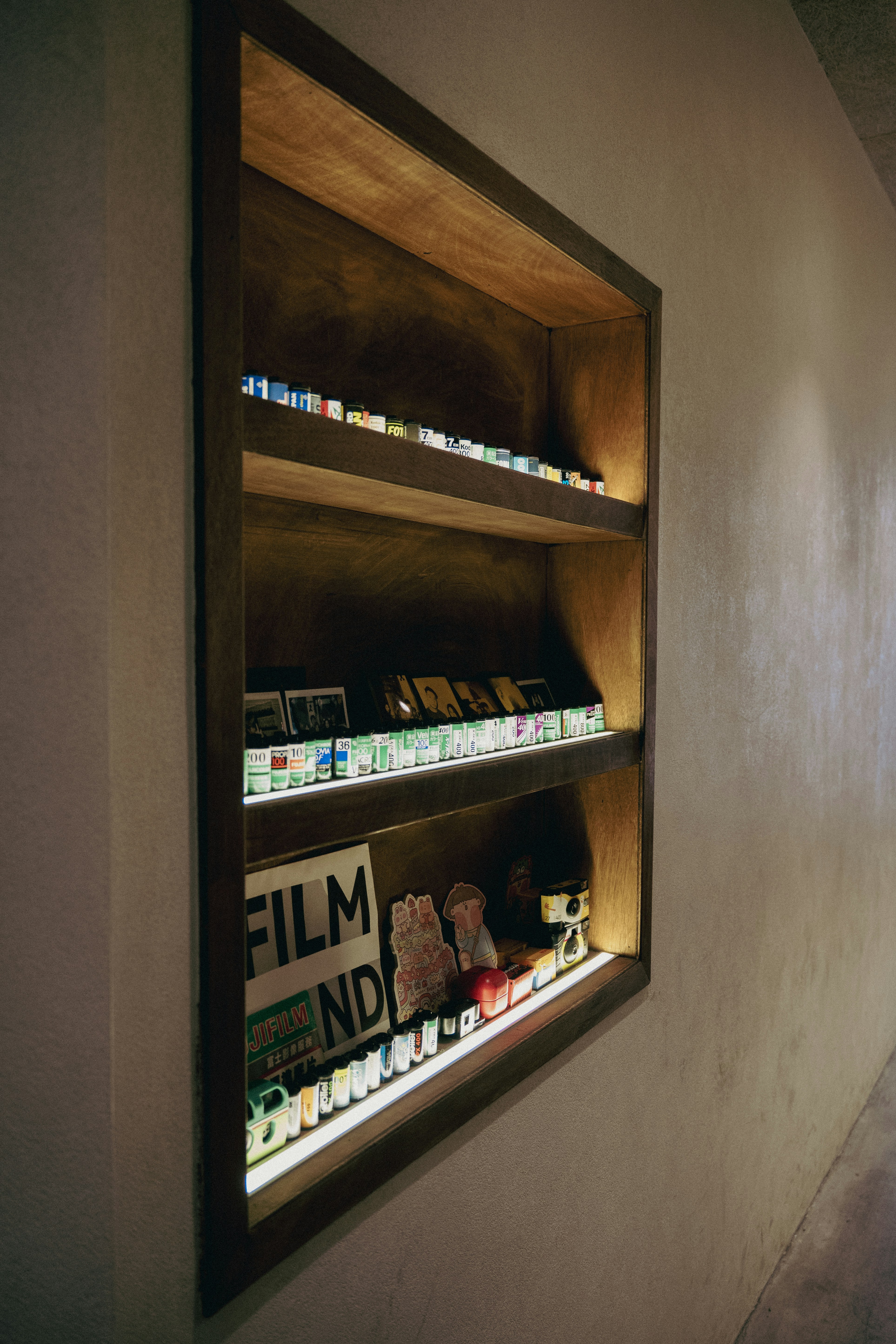 Warm-lit Recess: A Shelf of Tiny Colorful Packages