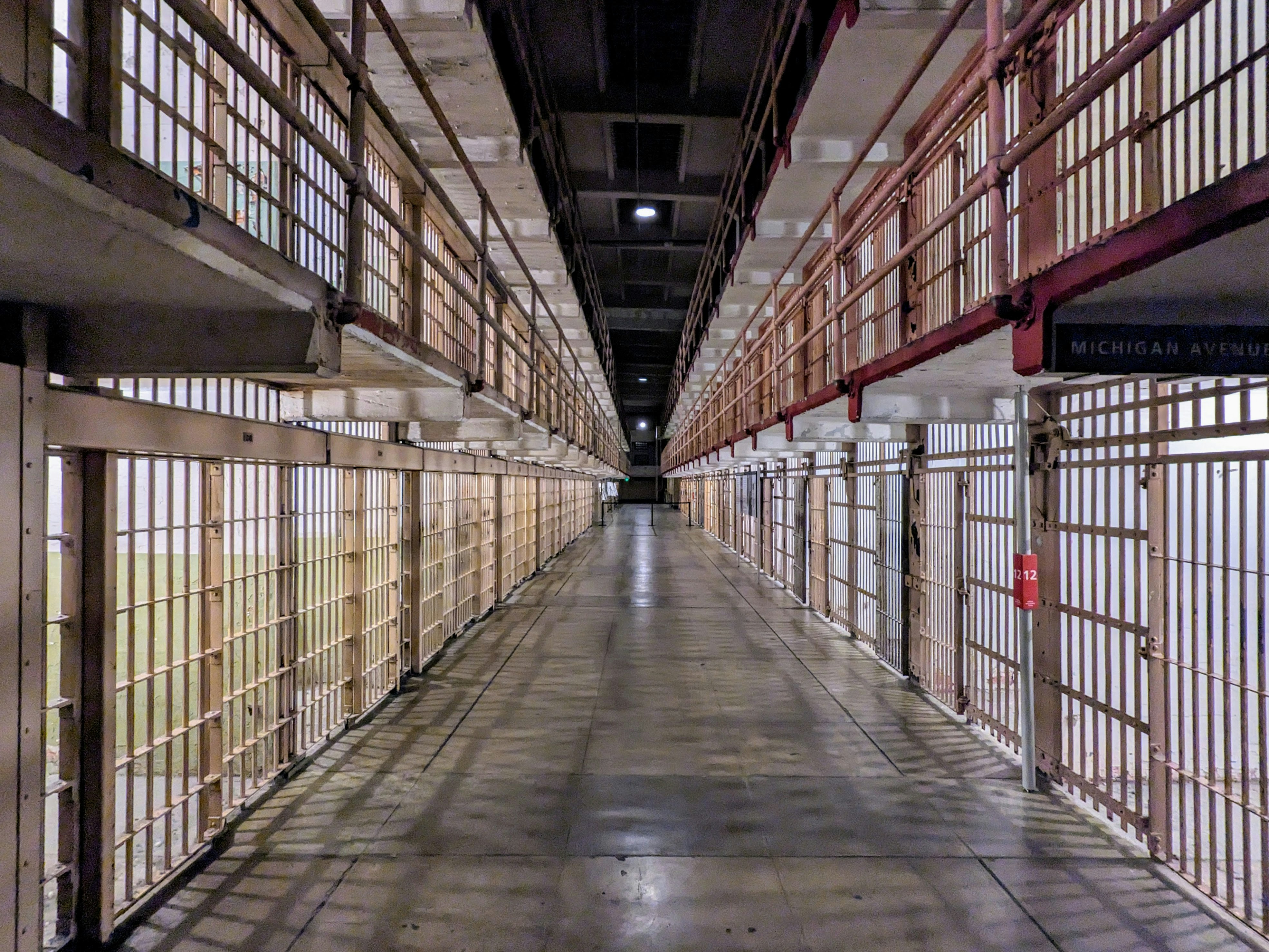 A long hallway in a jail with bars on the sides photo – Free Alcatraz ...