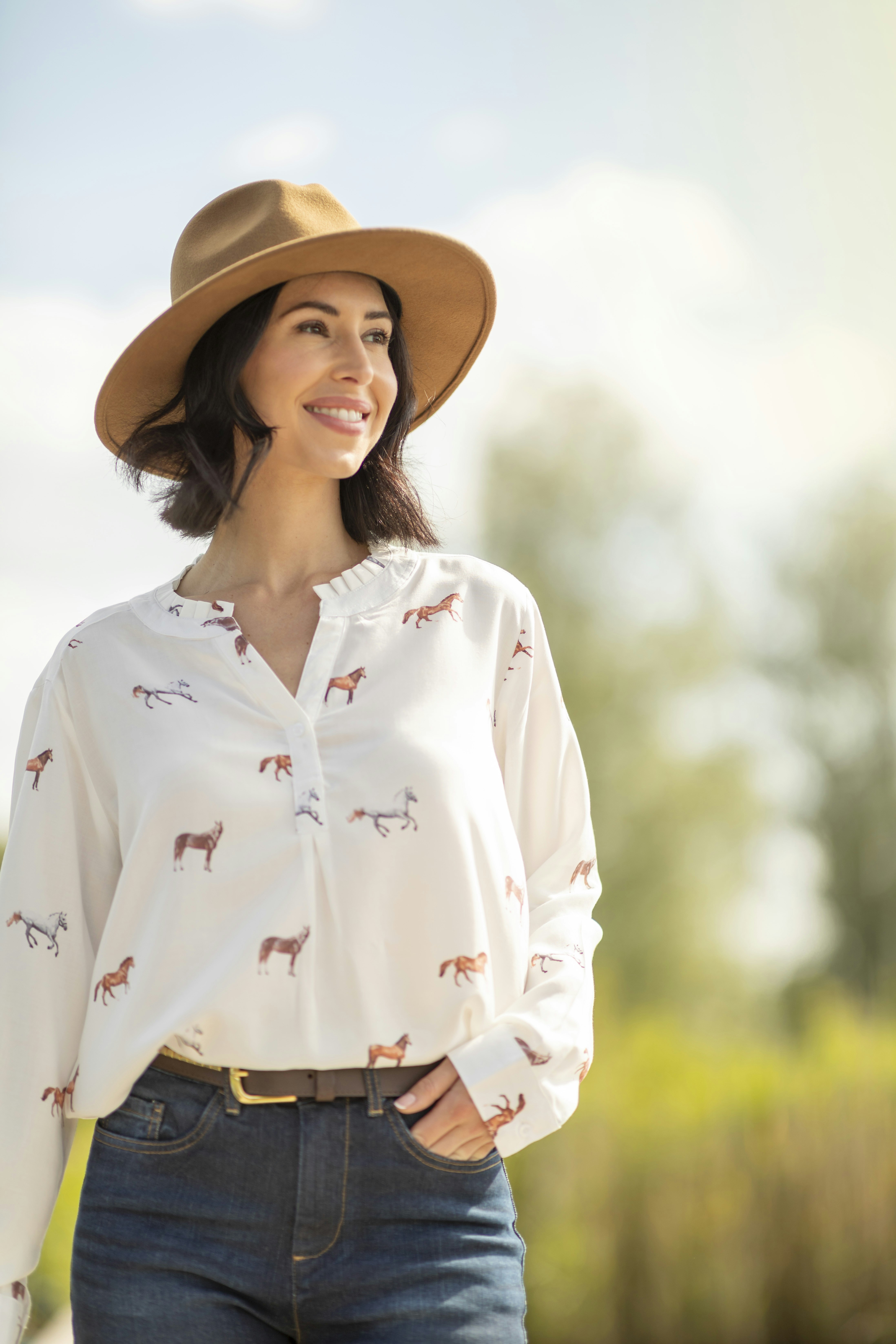 Sunlit Confidence: A Woman in a Horse-Pattern Blouse and Wide-Brim Hat