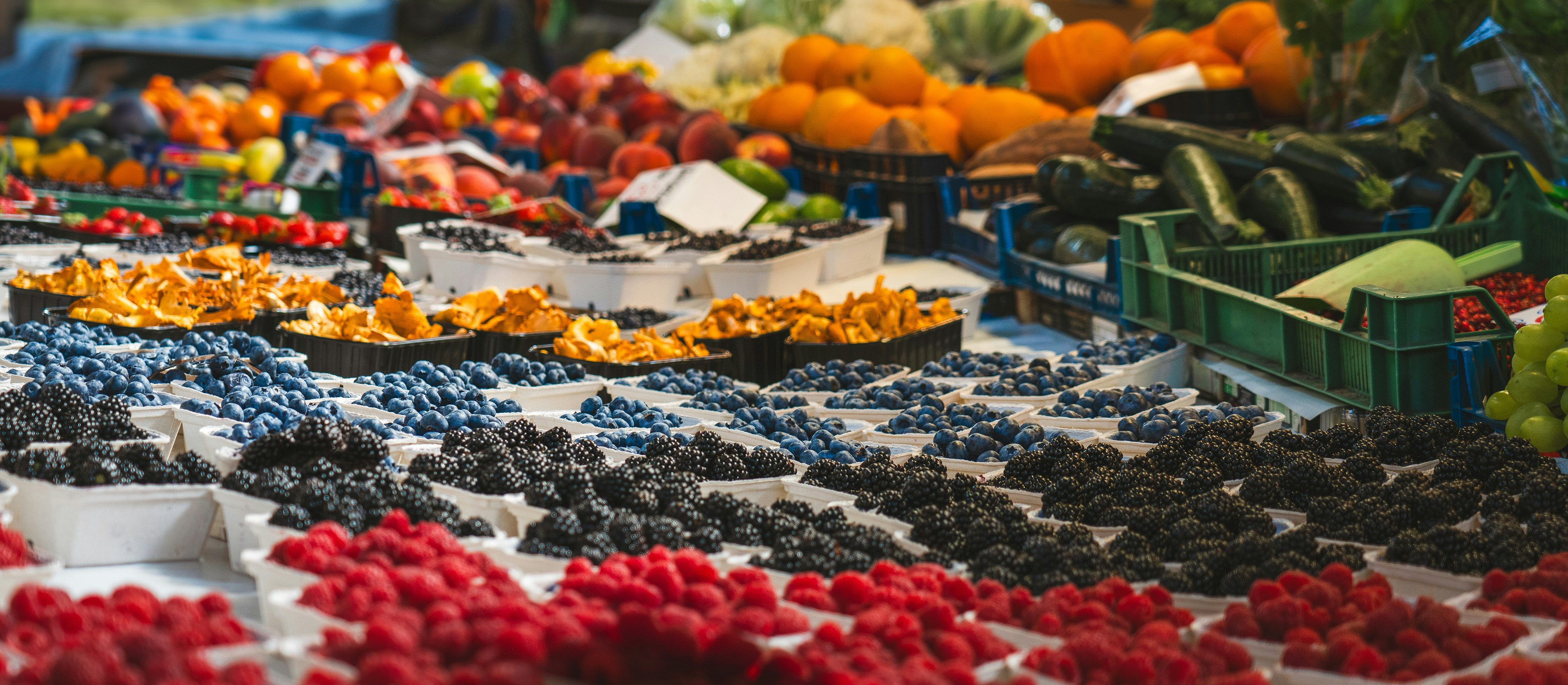 Sunlit Bounty: A Market Berry Stall in Living Color