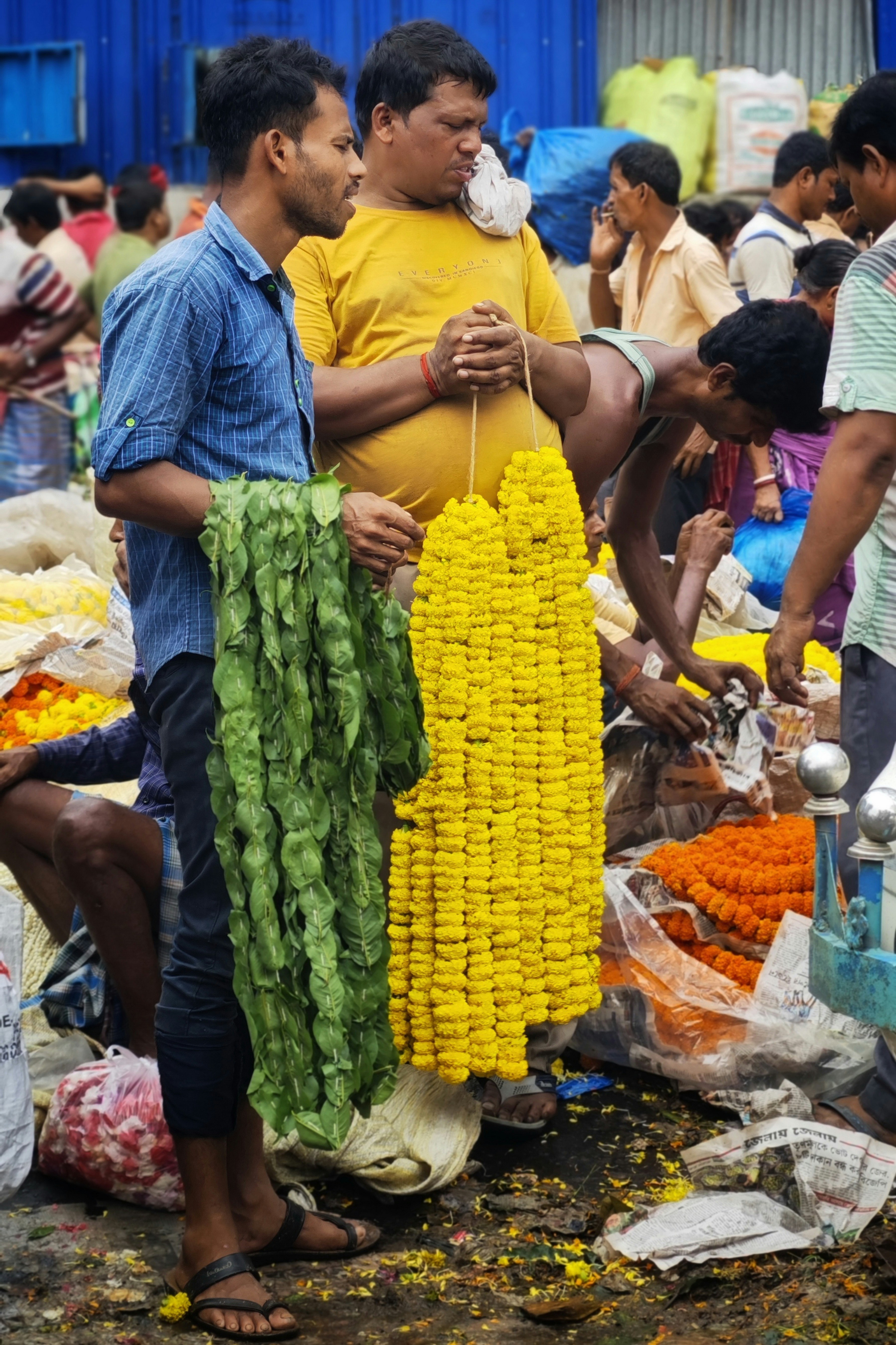 Golden Garlands at a Crowded Market Stand