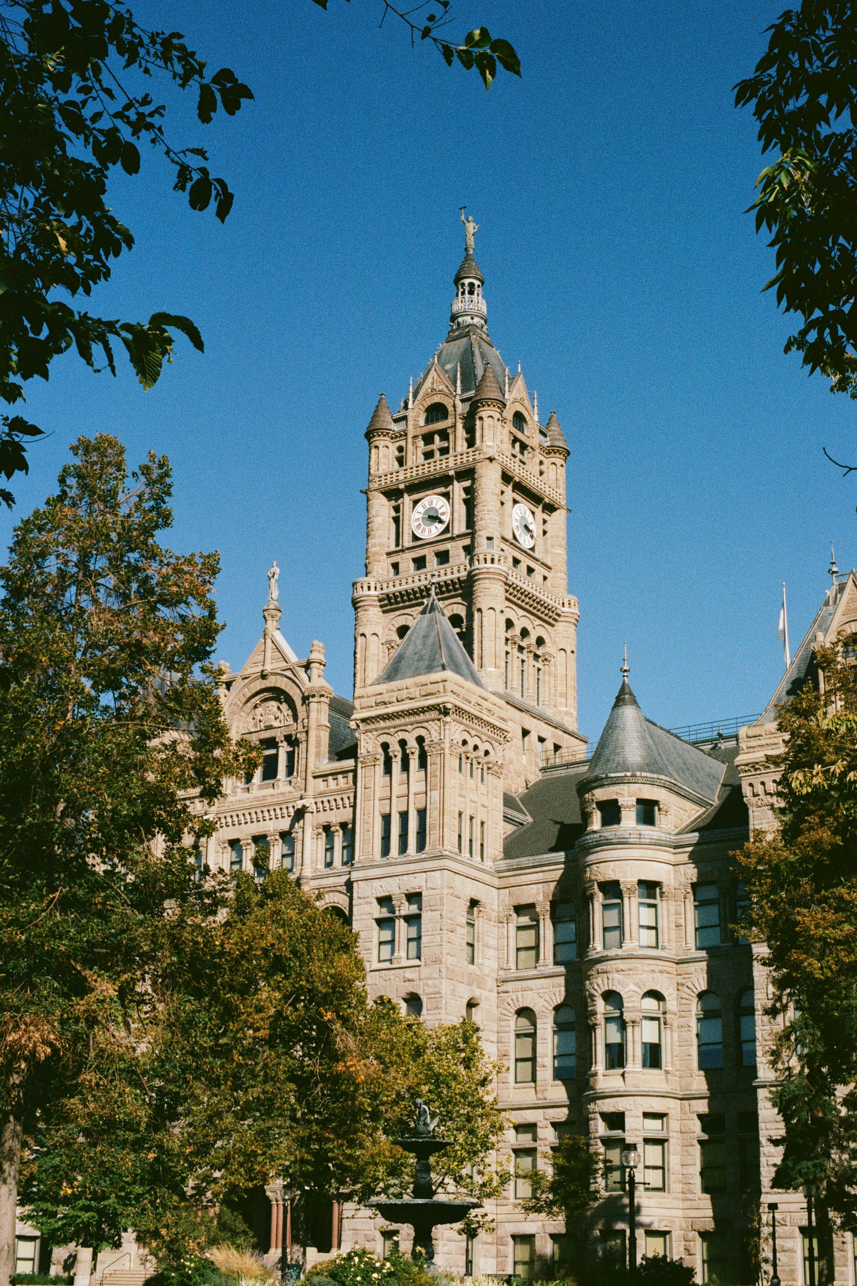 A large building with a clock tower on top of it photo – Free Ut Image ...