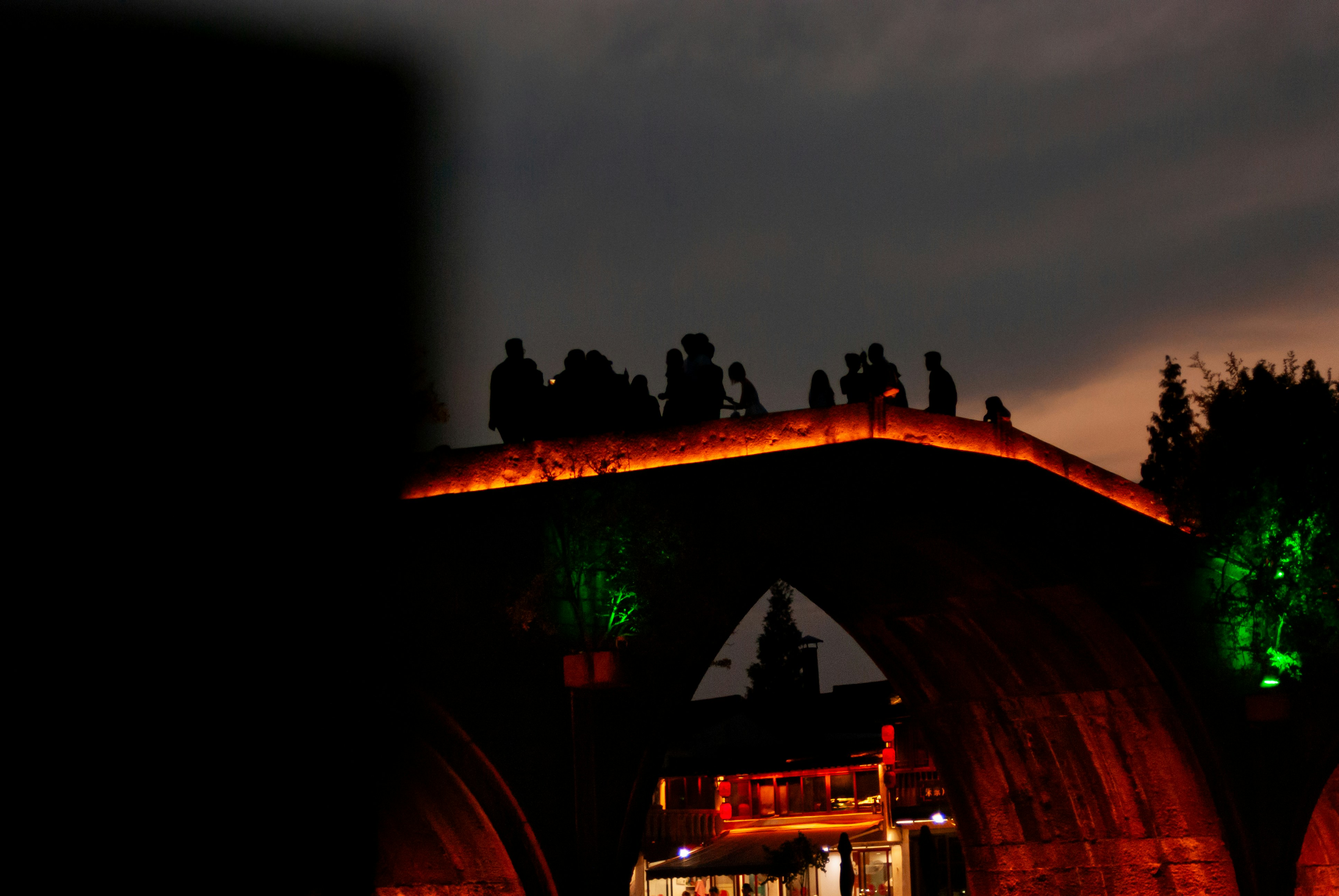 Twilight Silhouettes on the Glowing Bridge Arch