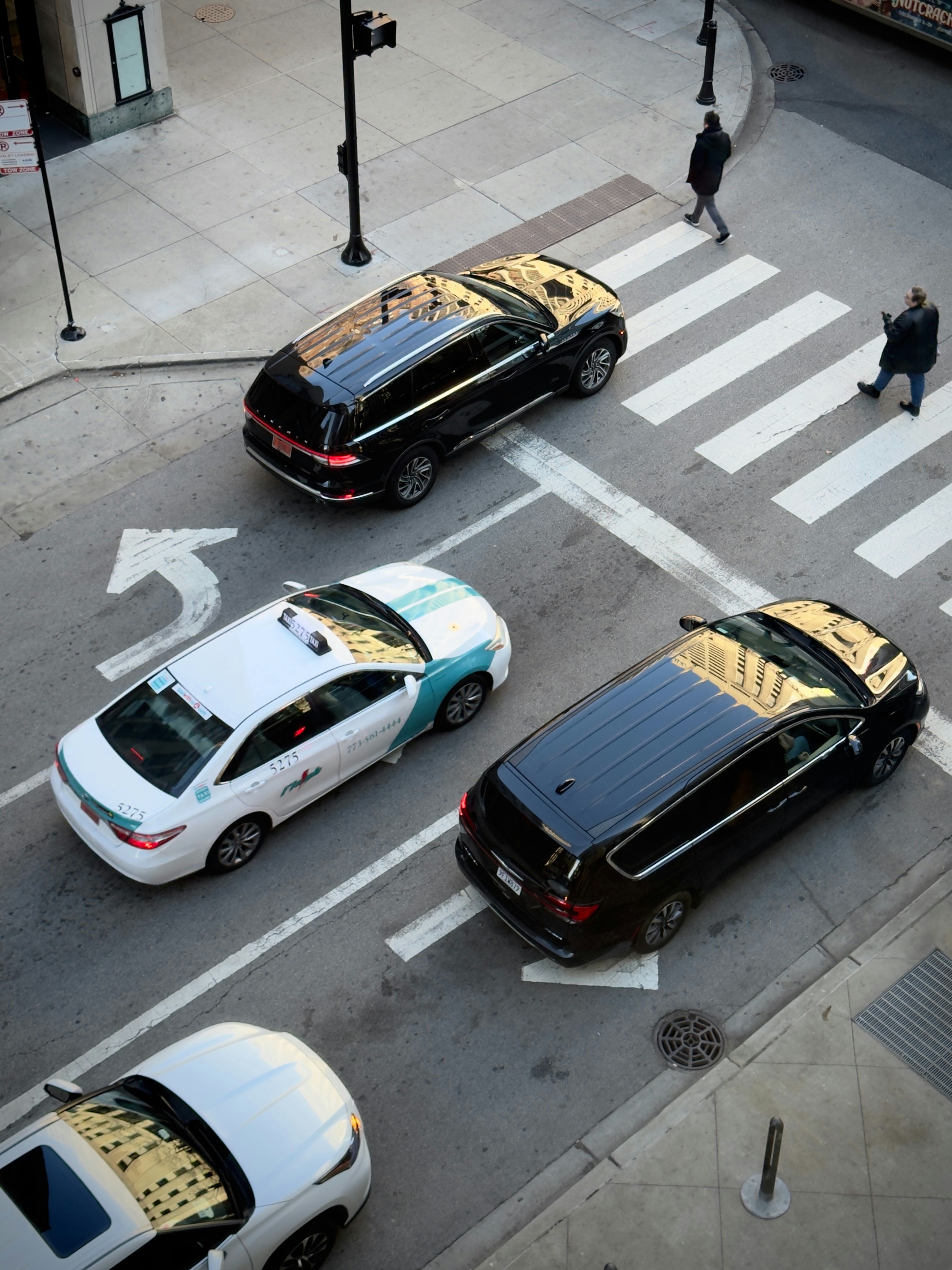 Aerial Rush: Cars Pause at a City Intersection