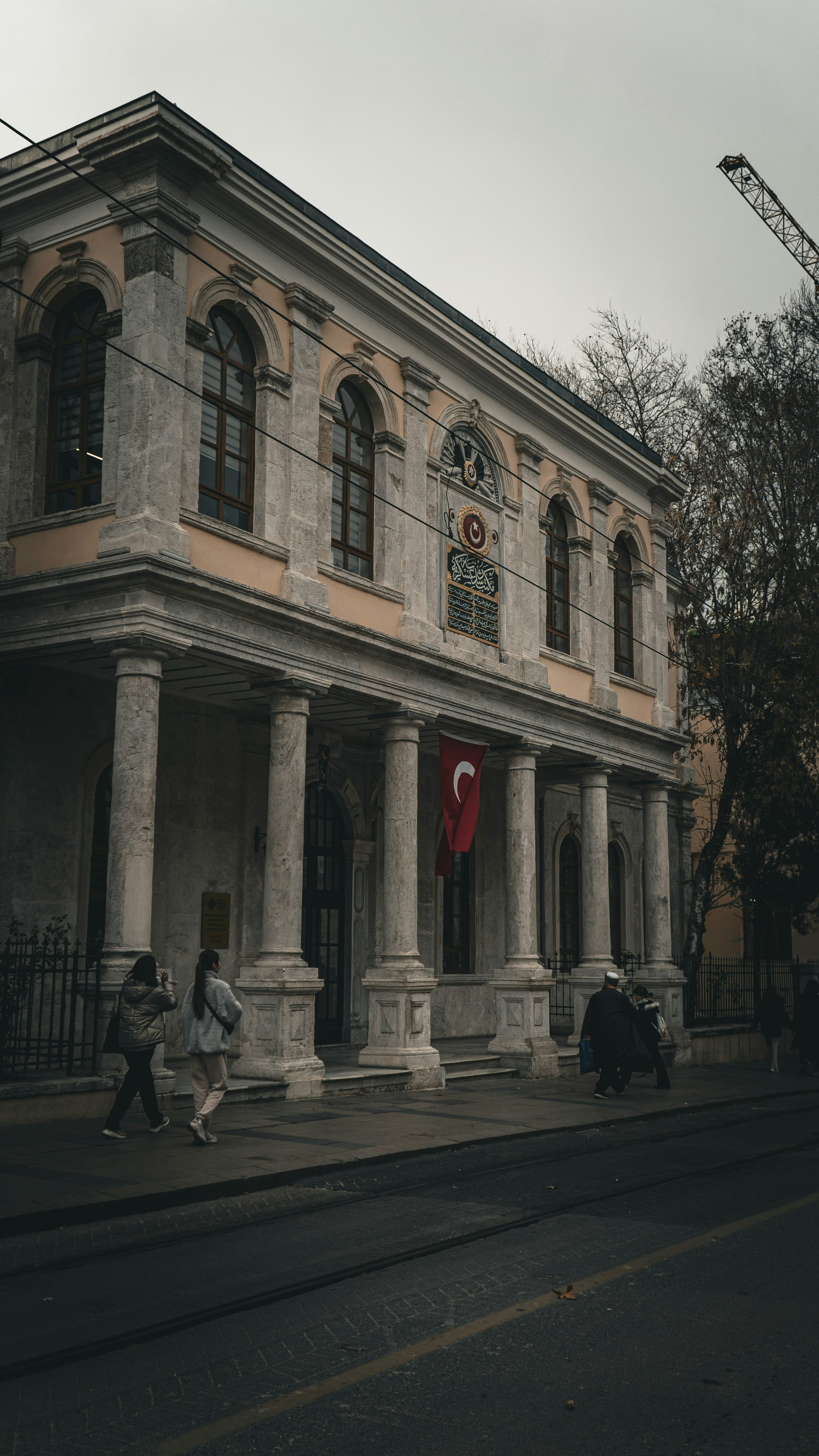 Flag Between Columns: A Turkish Streetfront in Muted Light