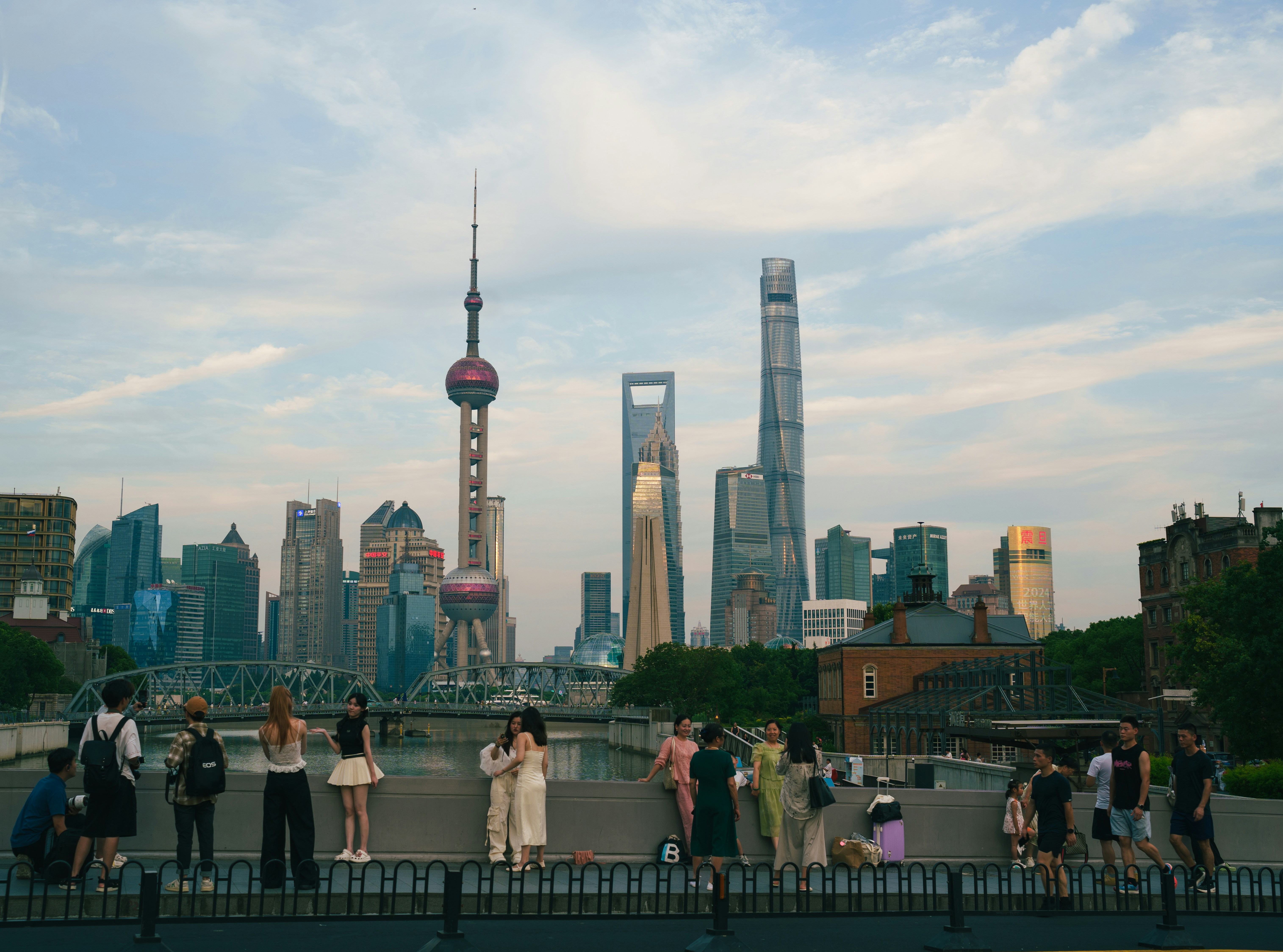 A group of people standing on top of a bridge photo – Free Shanghai ...