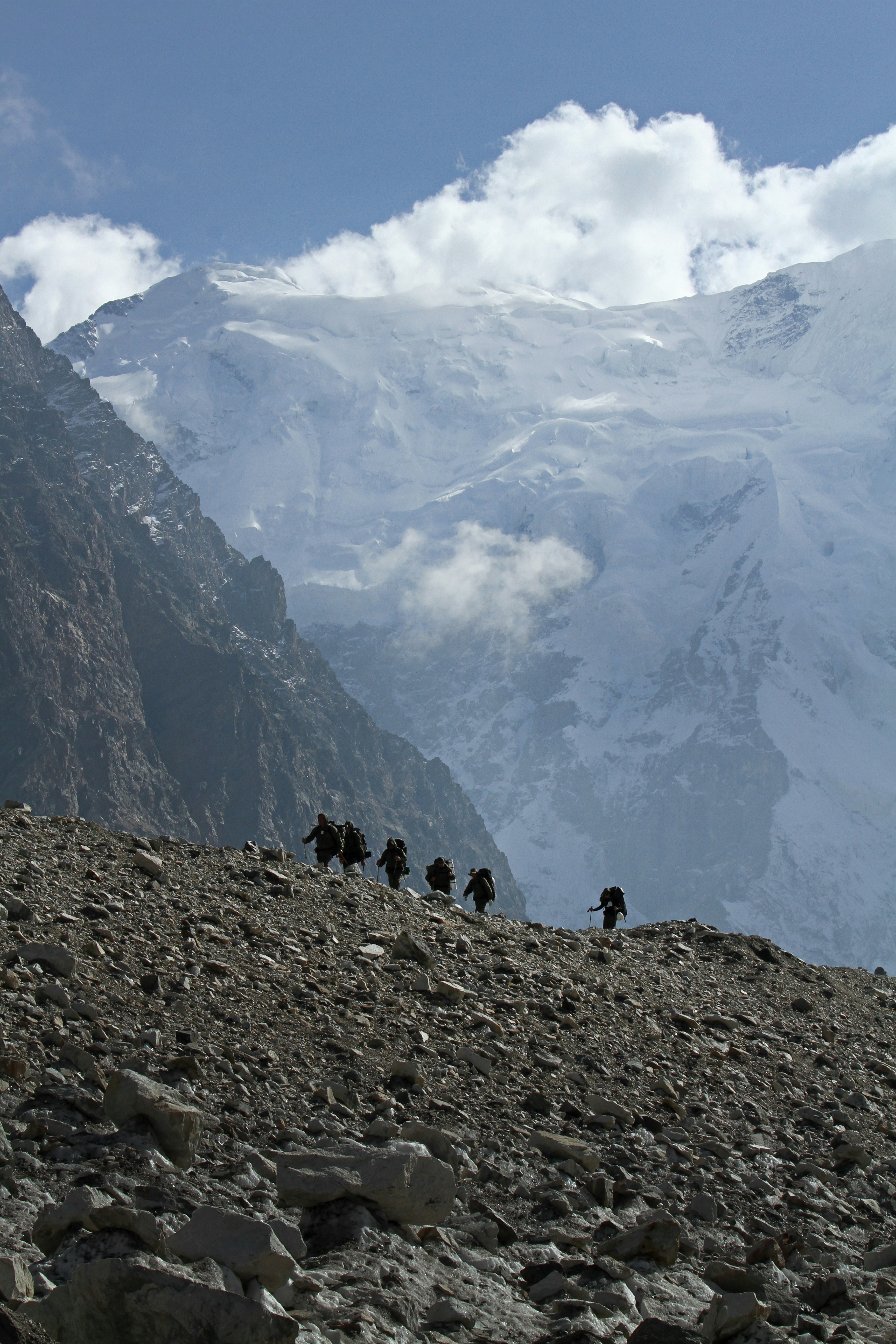 Small Team Trekker Ascent Beneath Imperial Glacier