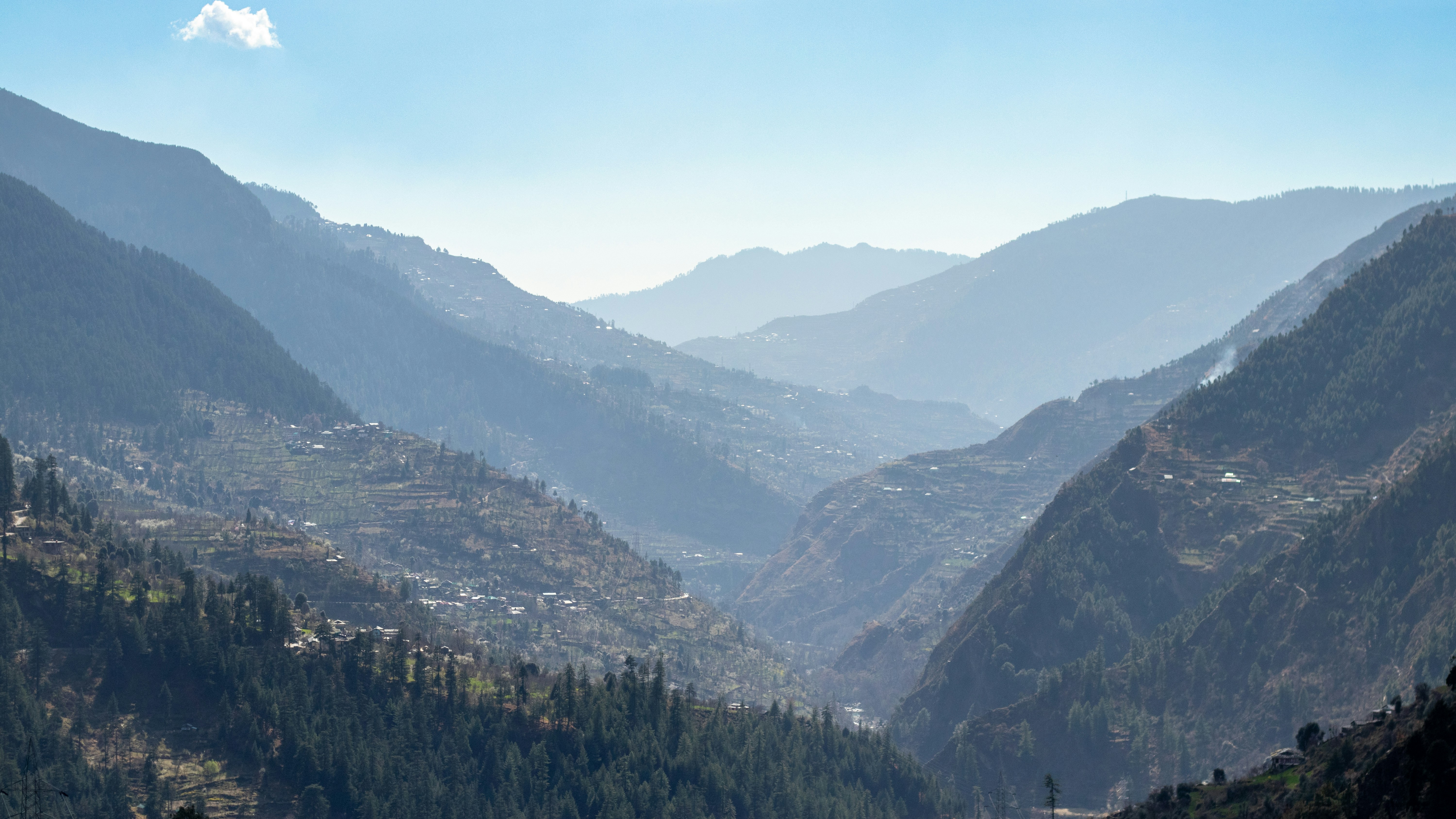 A view of a valley with mountains in the background photo – Free ...