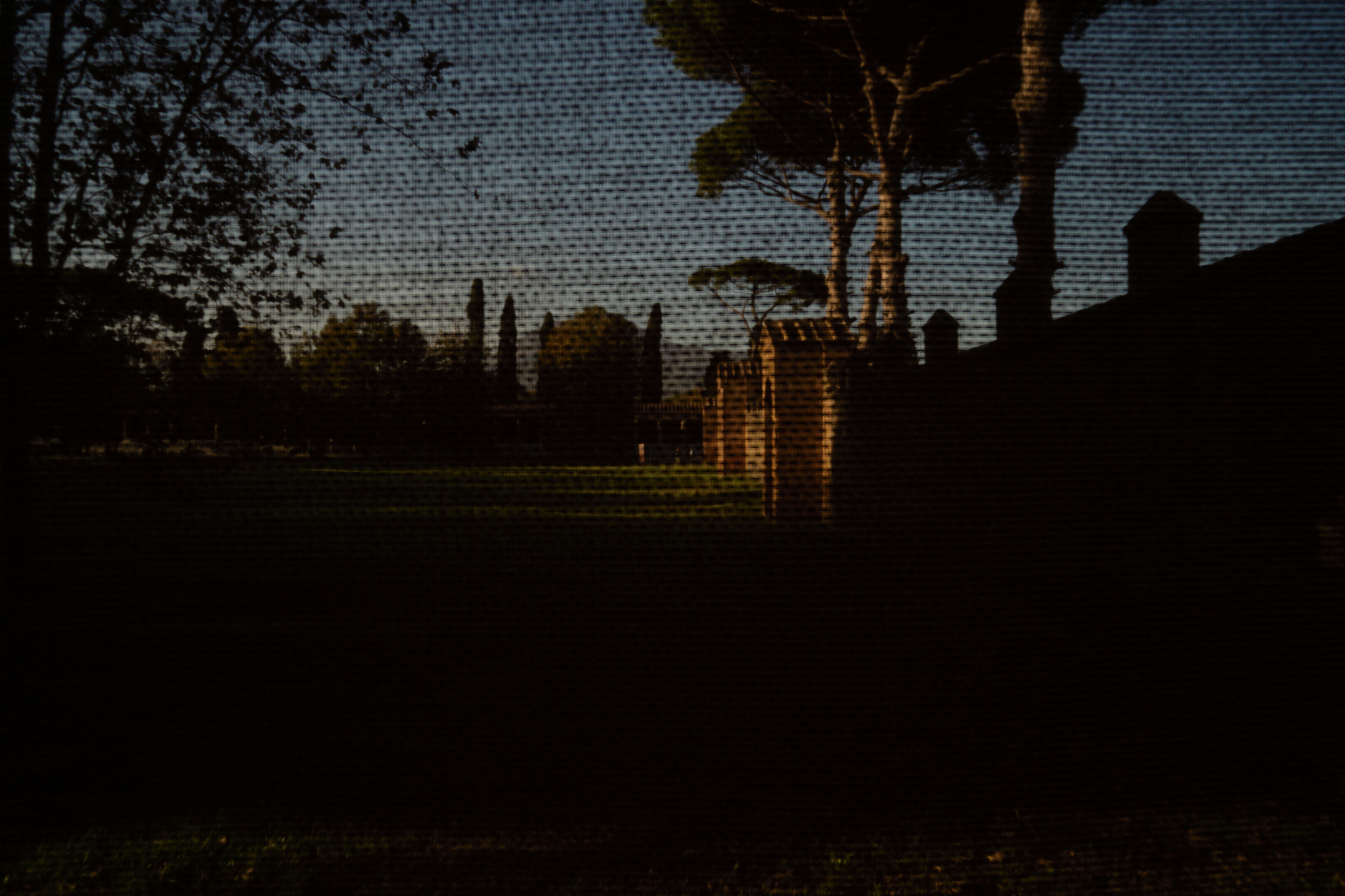 Moonlit Colonnade: Graveyard Silhouette in Dim Evening Light