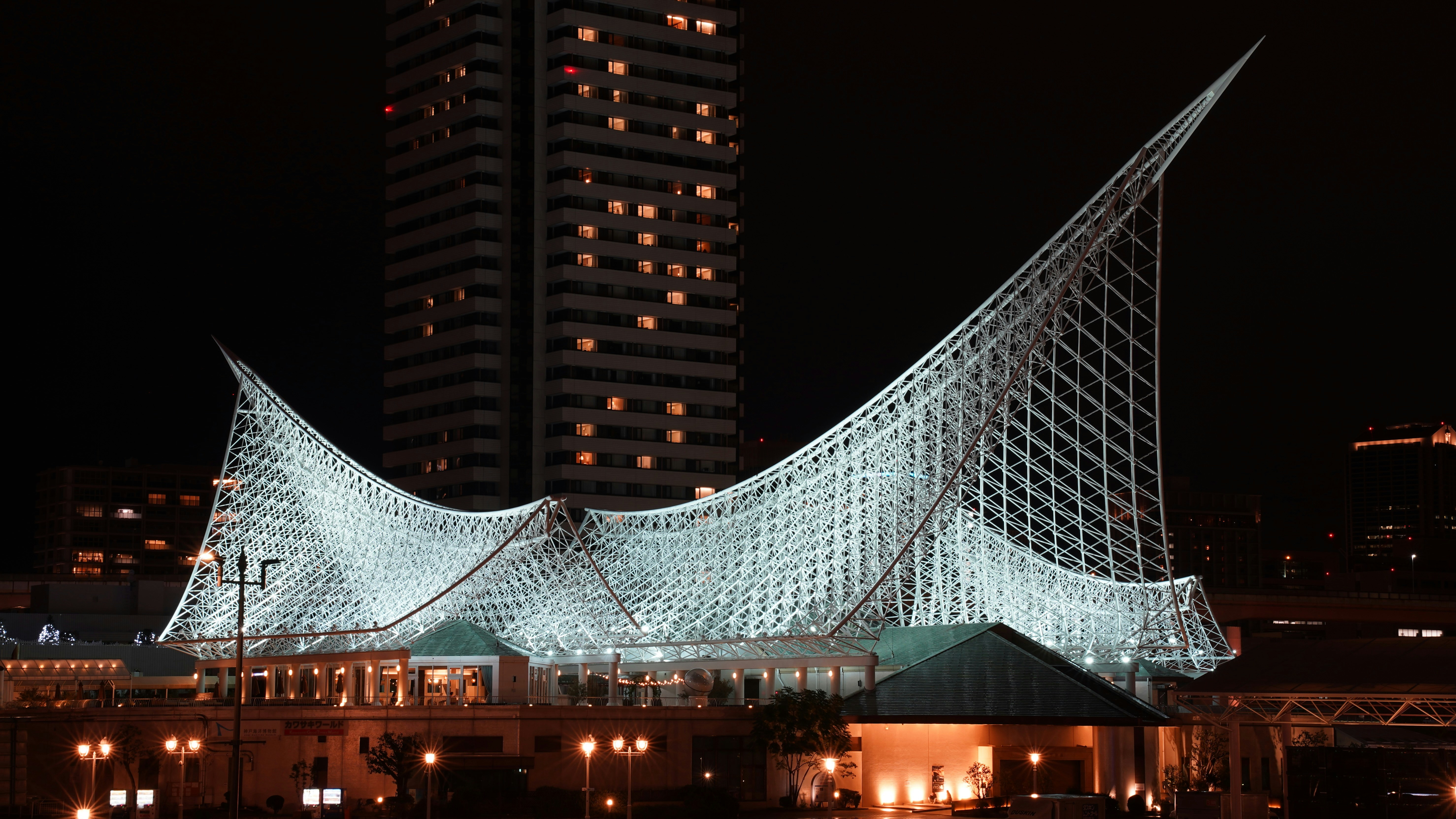 A large building with a very tall building in the background photo ...