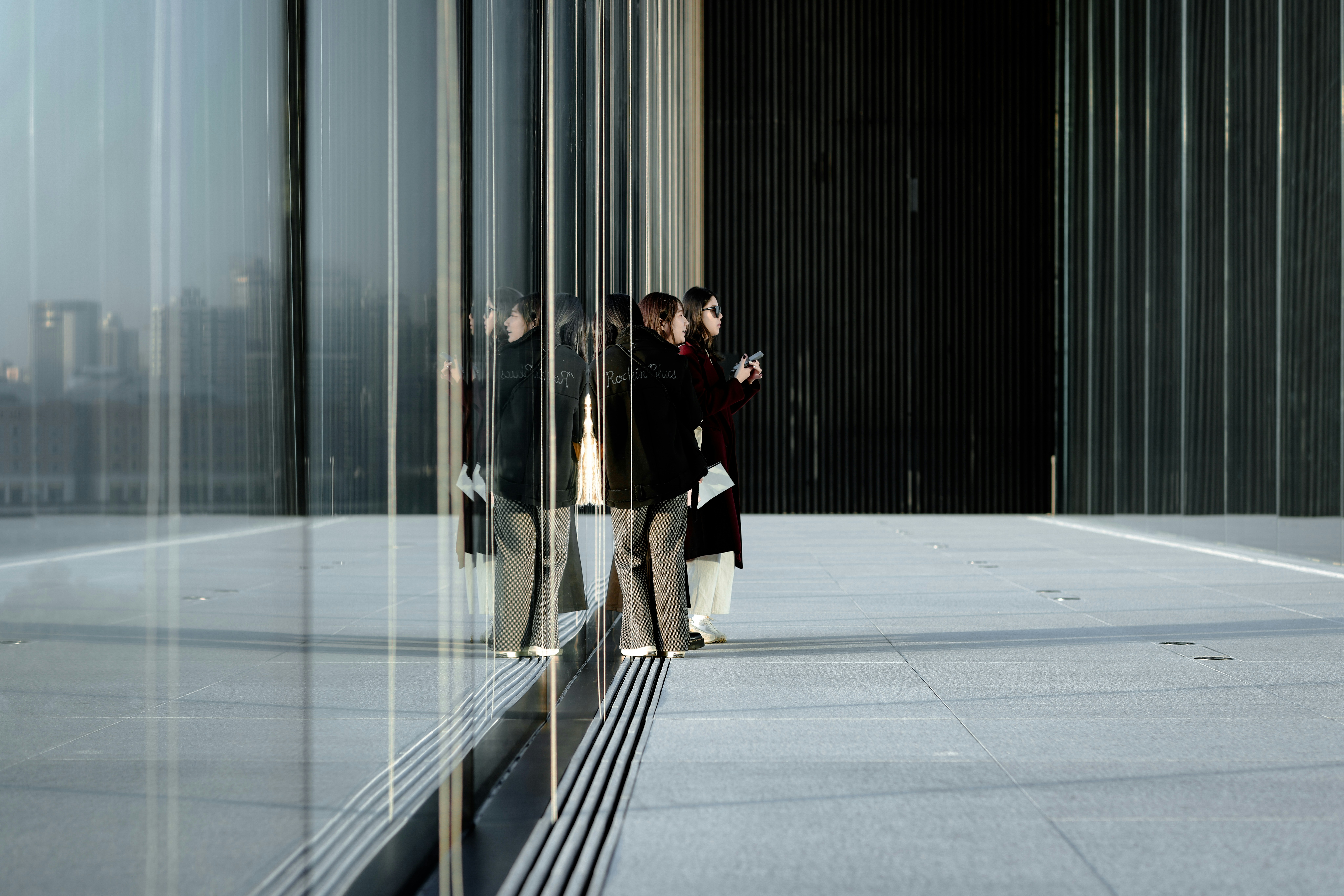 Conversations in Reflection: Faces Along a Glass-Walled Corridor