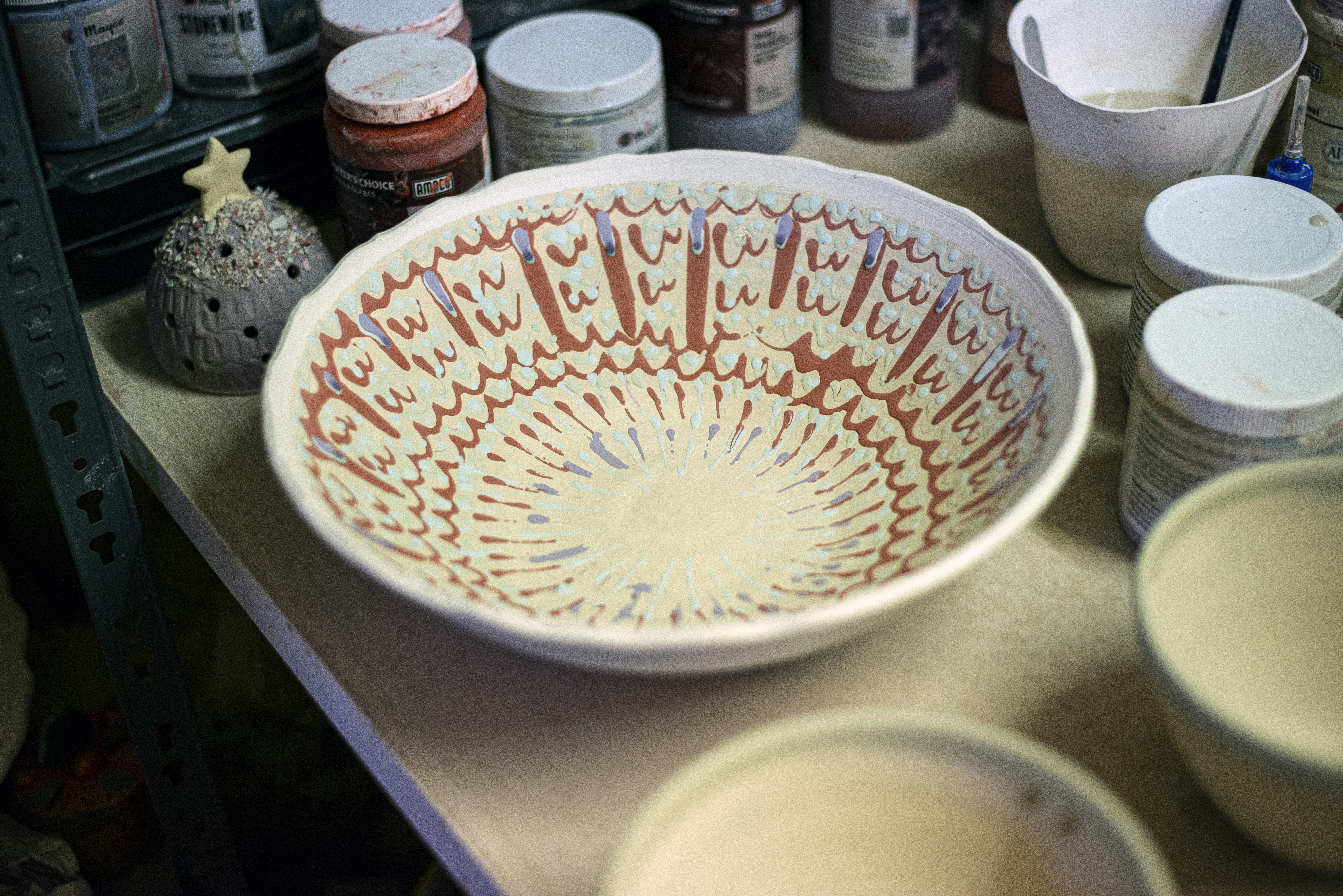 Spiral in Clay: A Painted Bowl in a Studio Corner