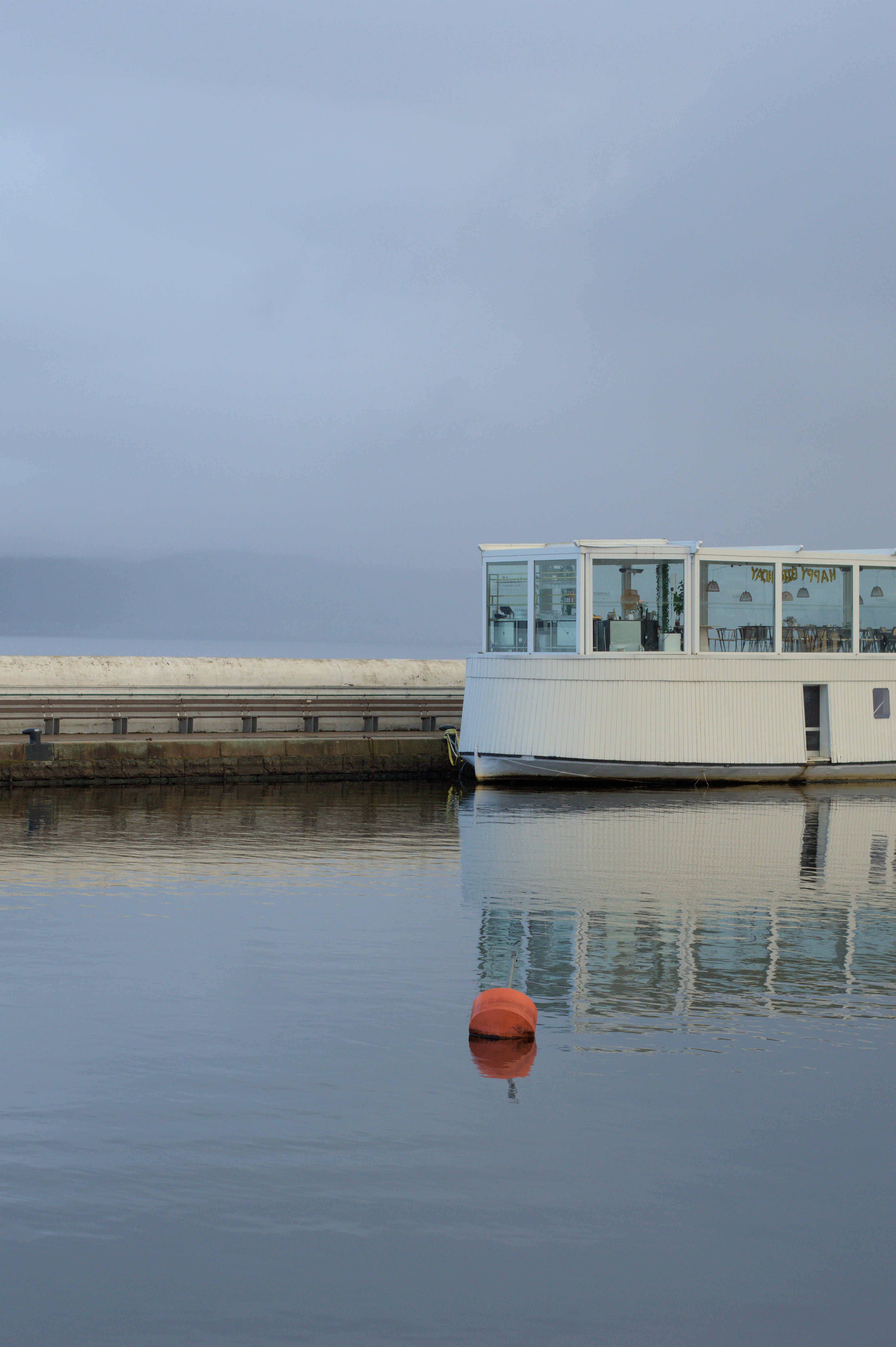 Glass-Box Harbor: A Quiet Marina with a Red Beacon