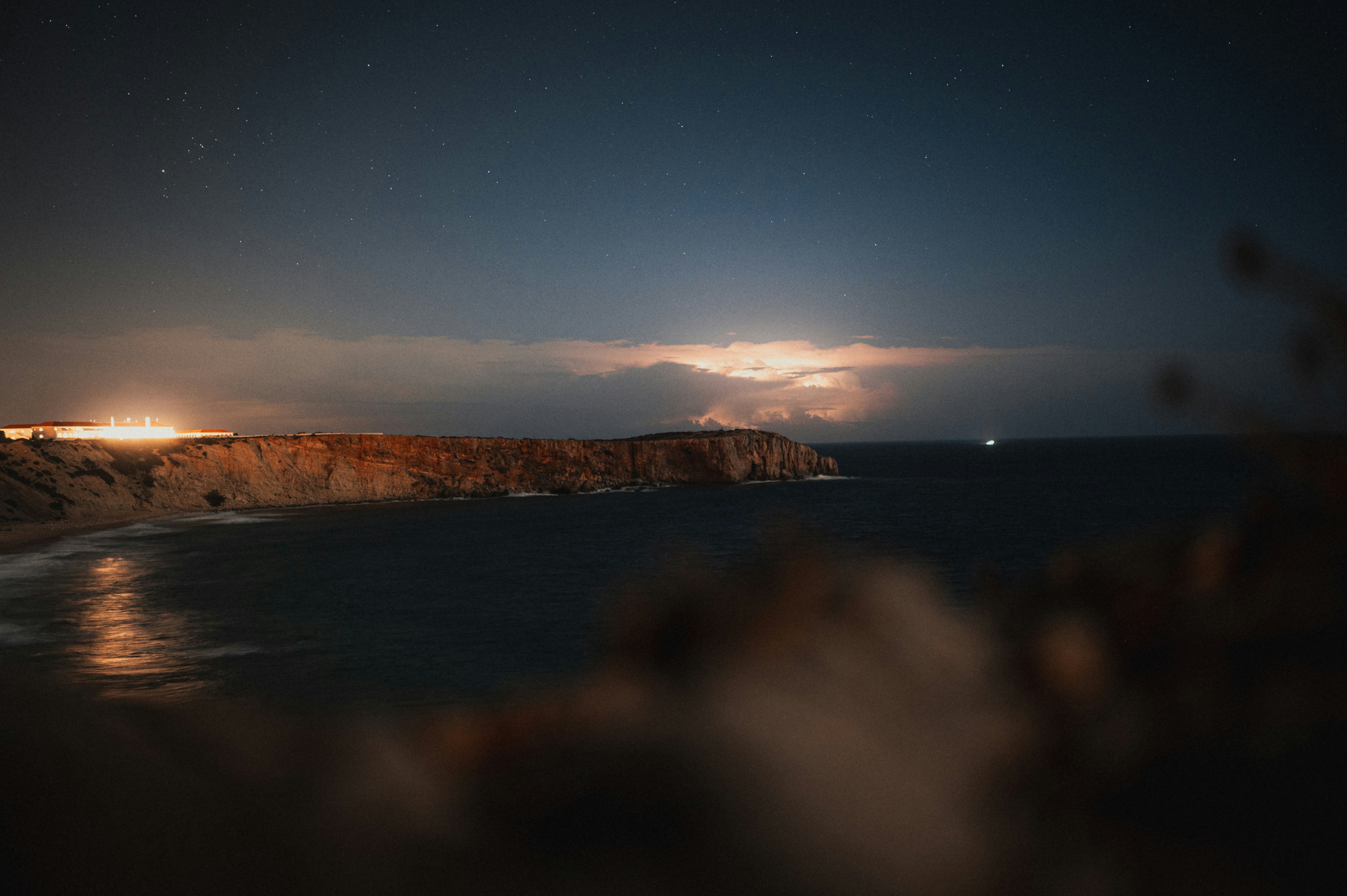 Cliff Edge Under a Starry Quiet: Harbor Light Traces the Night Sea