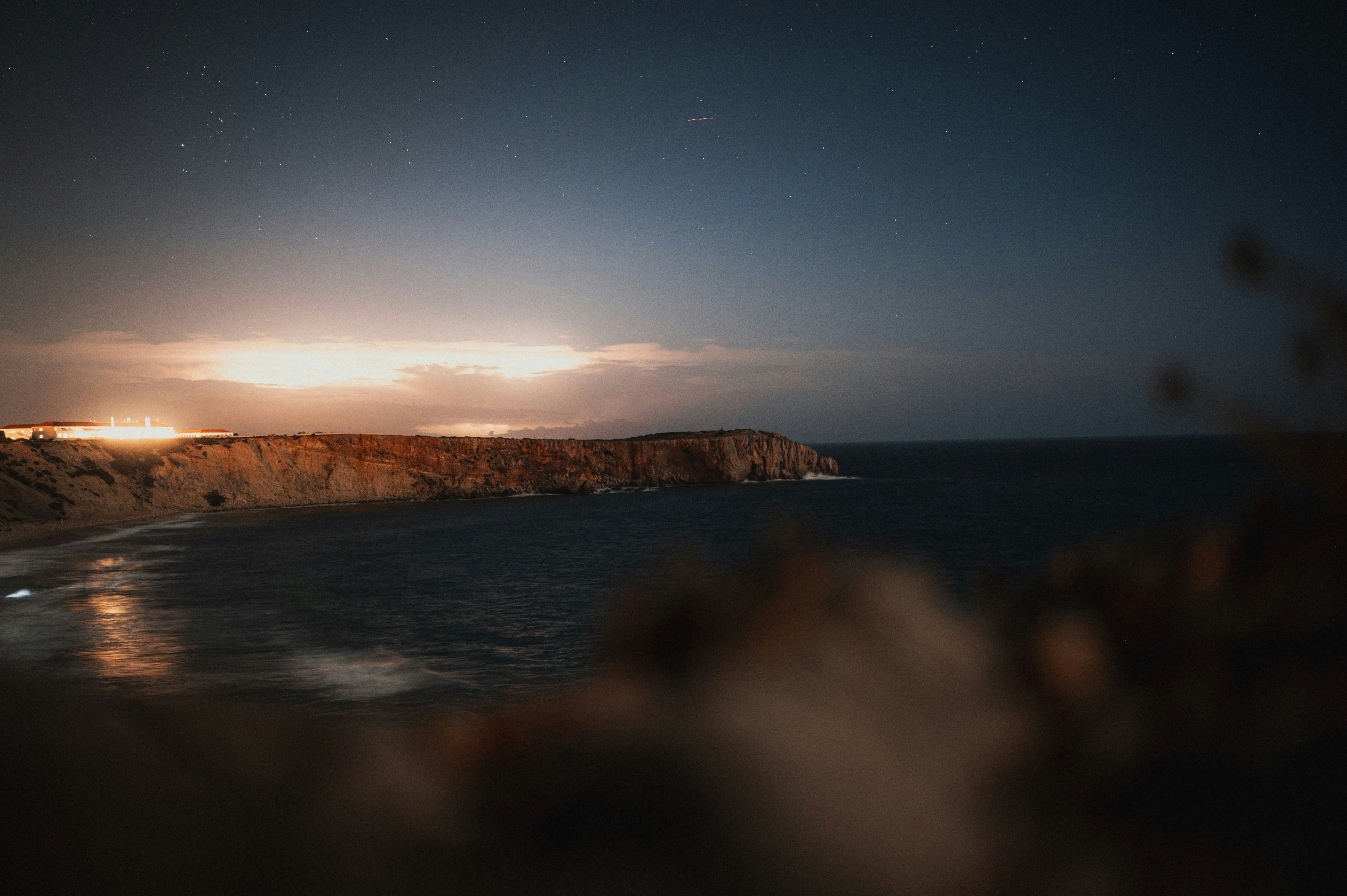 Moonlit Cliff Echoes: A Quiet Sea Under a Starry Veil