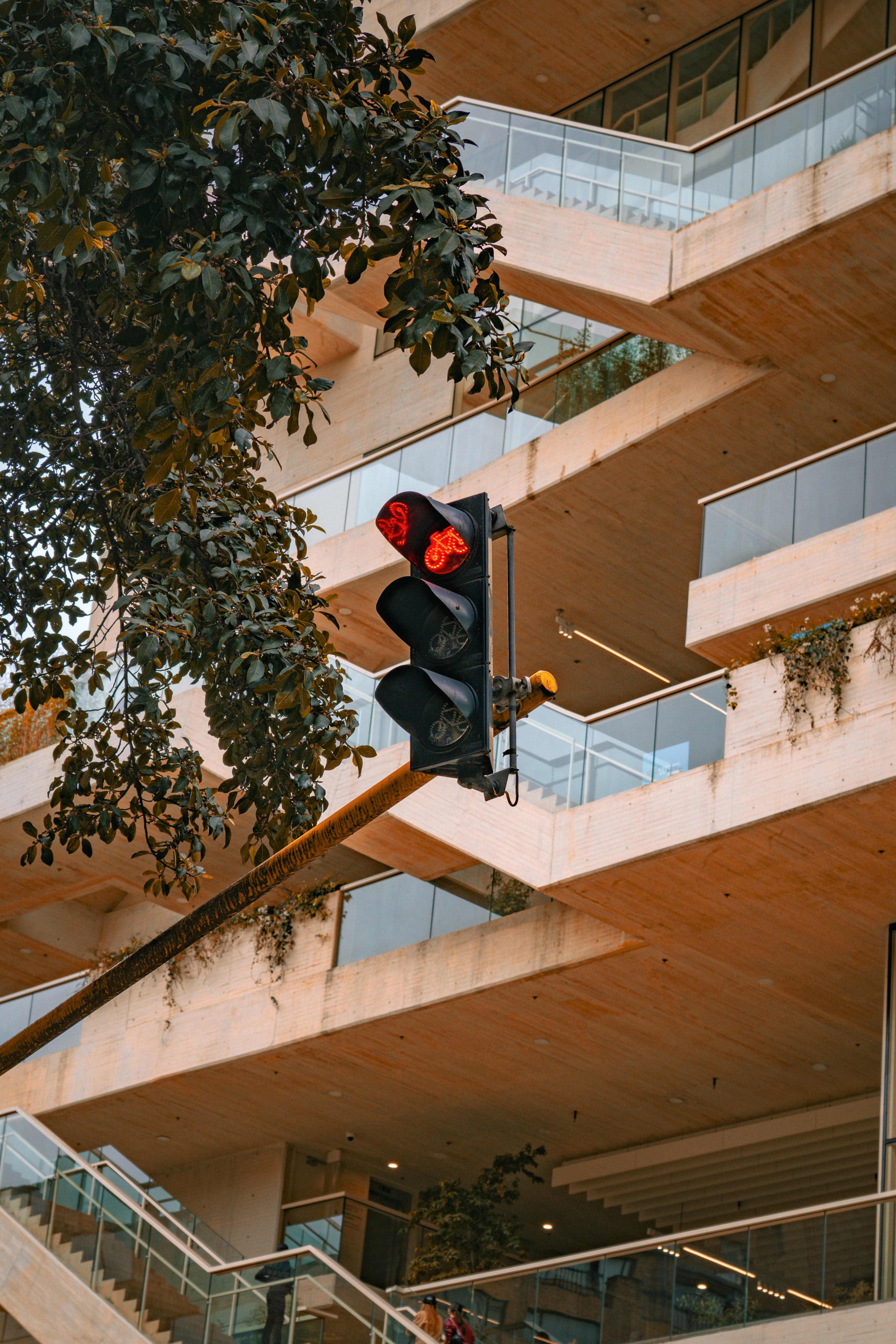 A traffic light hanging from the side of a building photo – Free Bogotá ...