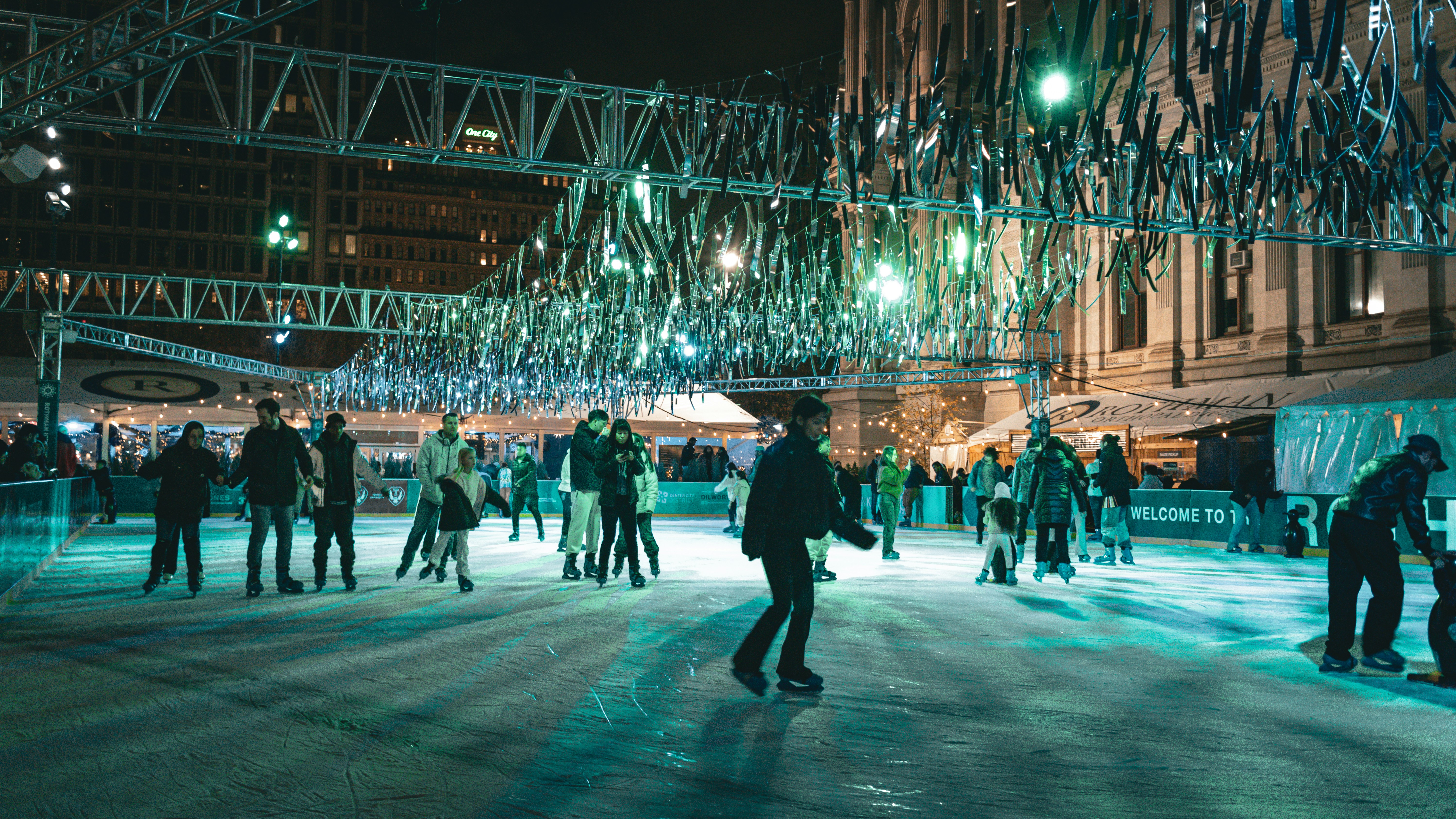A group of people skating on an ice rink