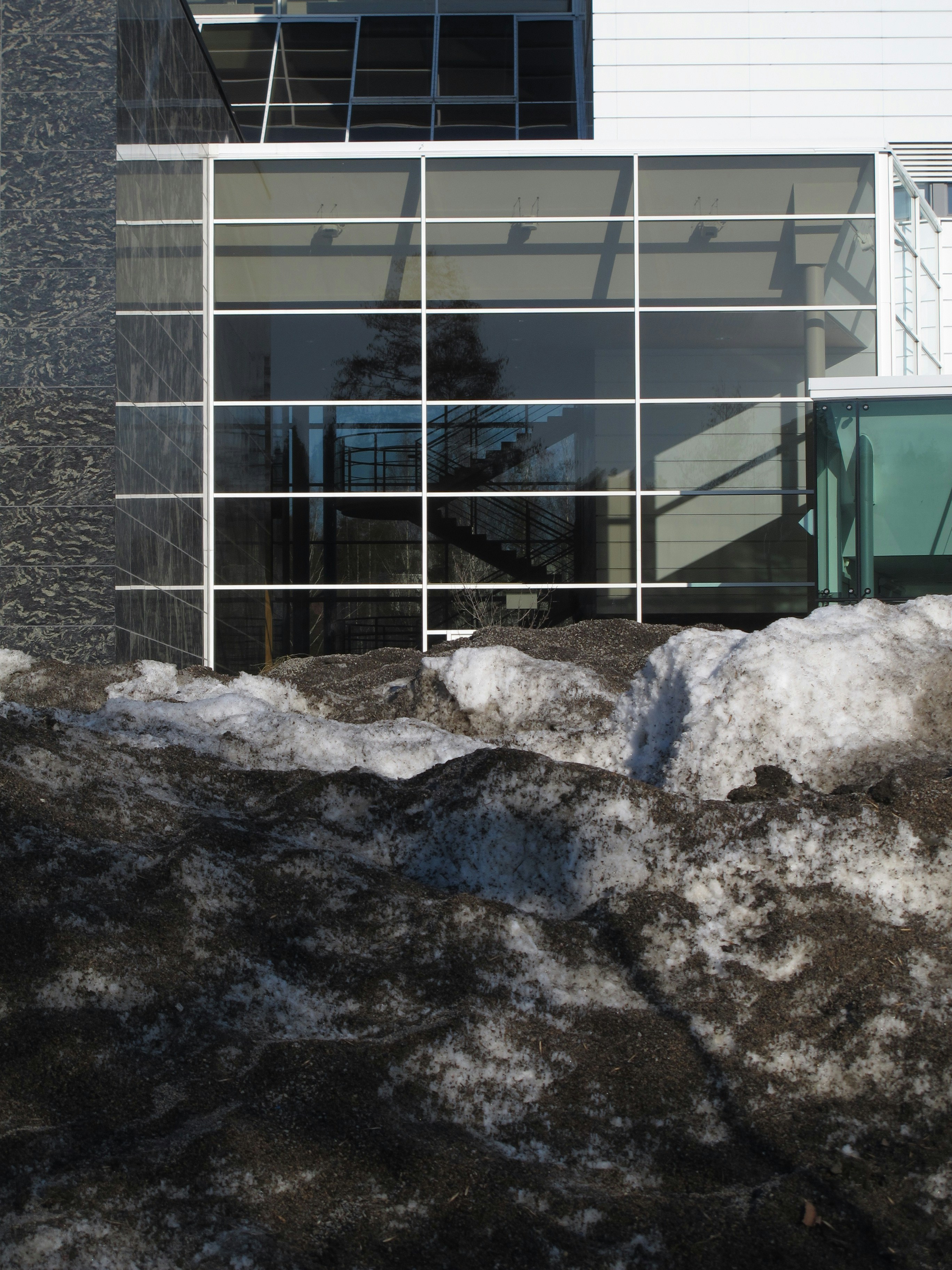 Grid of Glass and Snow: A Modern Facade's Quiet Reflection