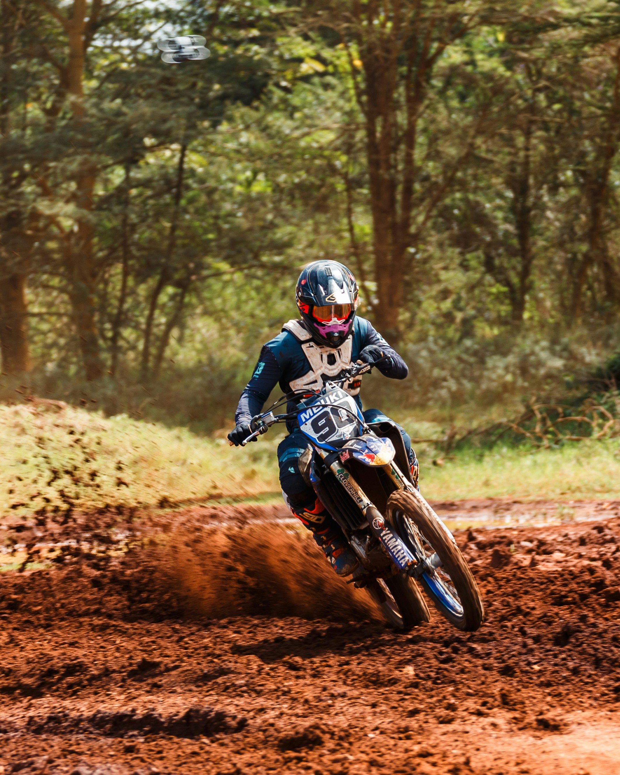 A man riding a dirt bike on top of a dirt field photo – Free Woman ...