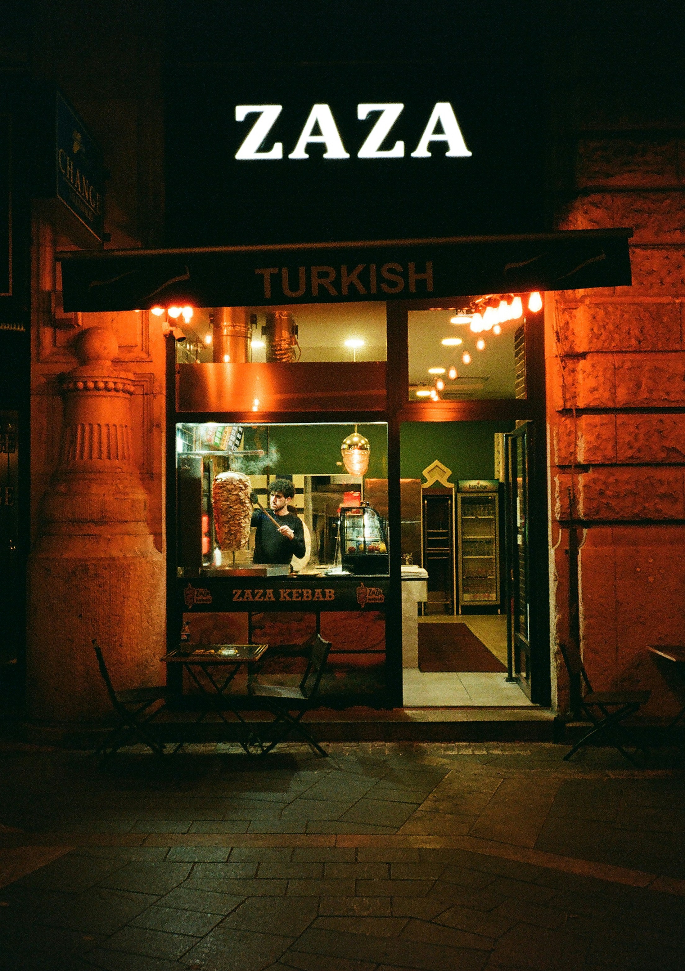 A store front at night with lights on photo – Free Film photography ...