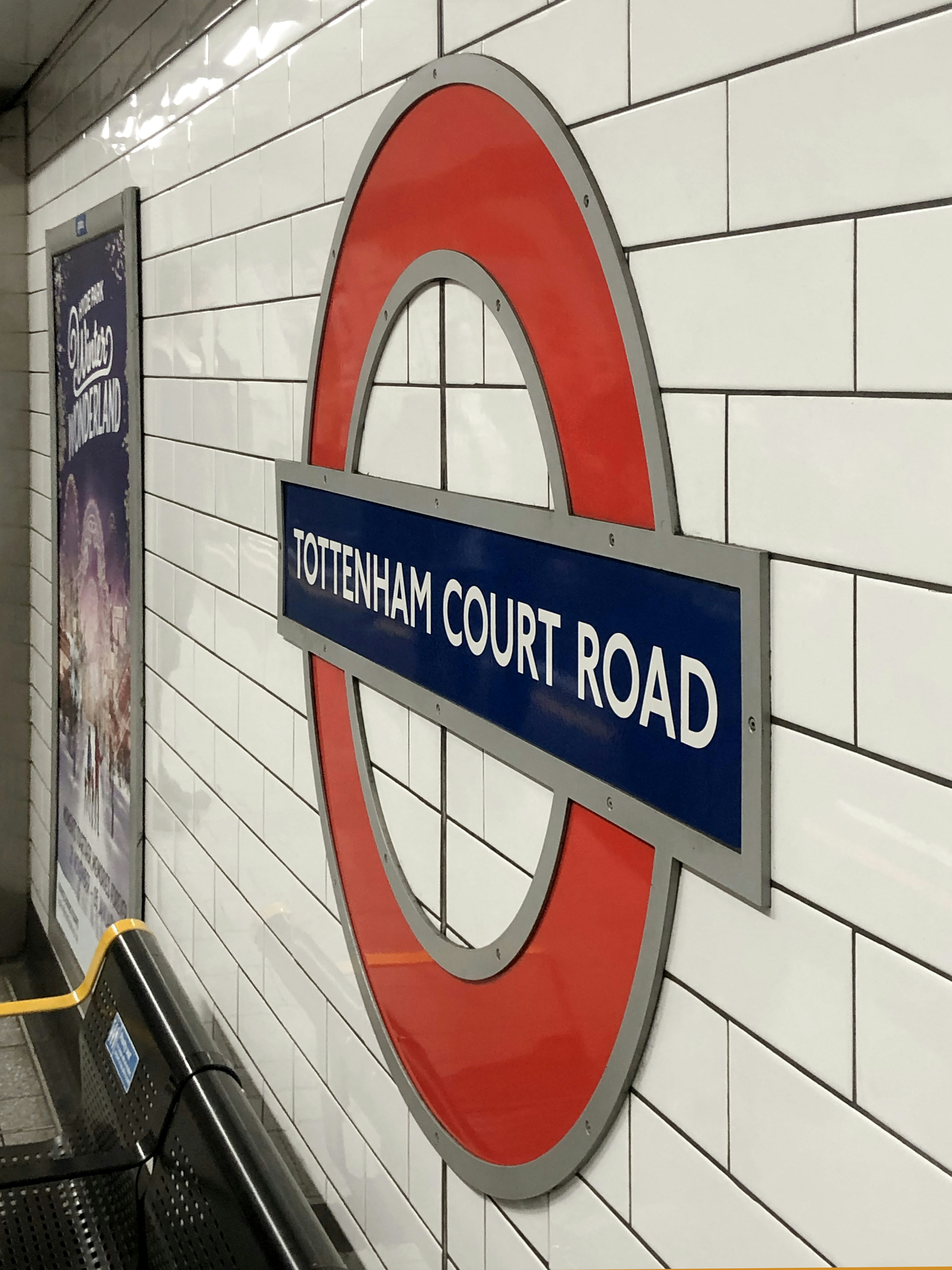 Circular Signature: Tottenham Court Road Roundel Anchoring a Subway Wall