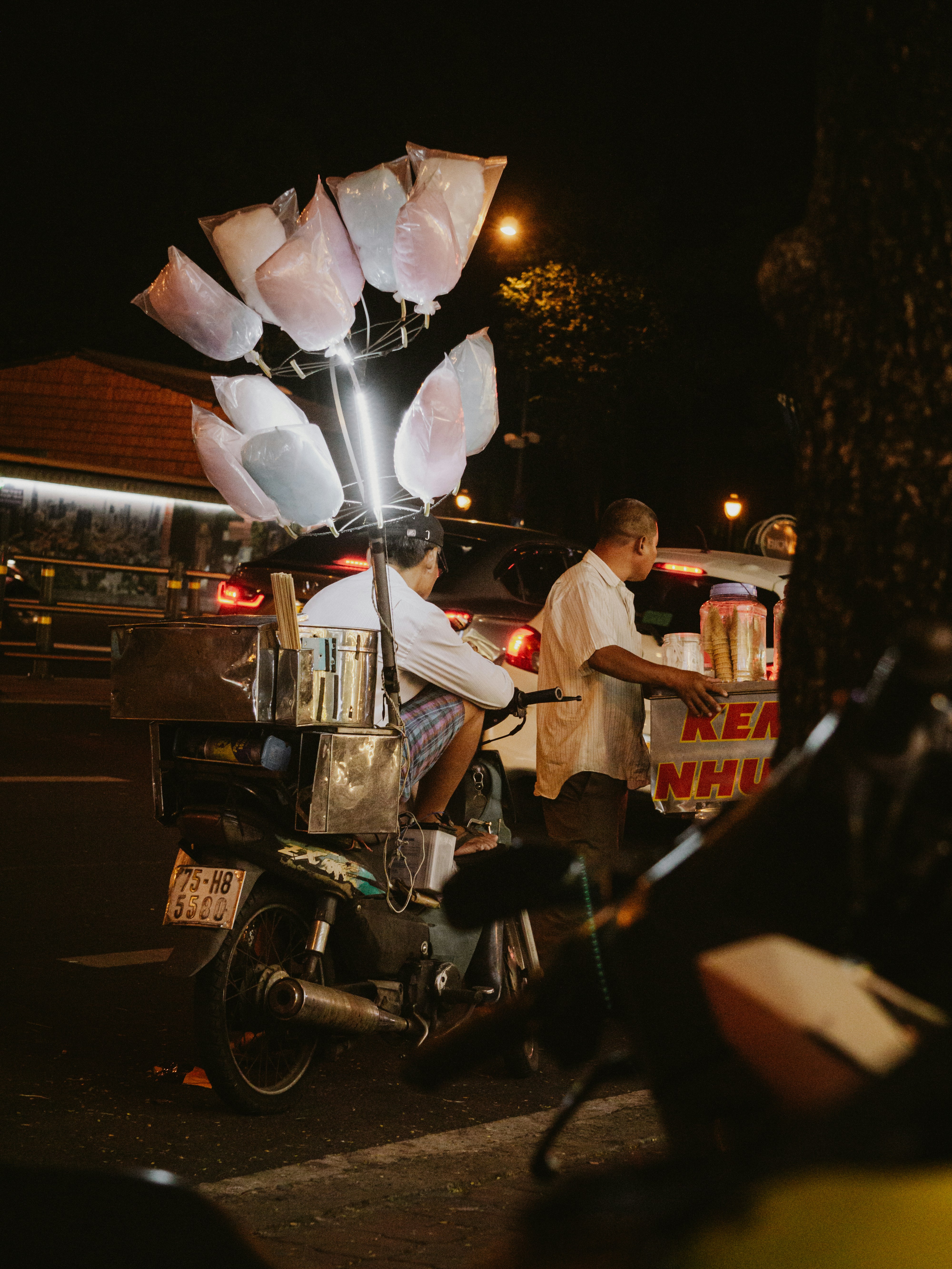 Night Market Scooter Cart Under a Sky of White Balloons