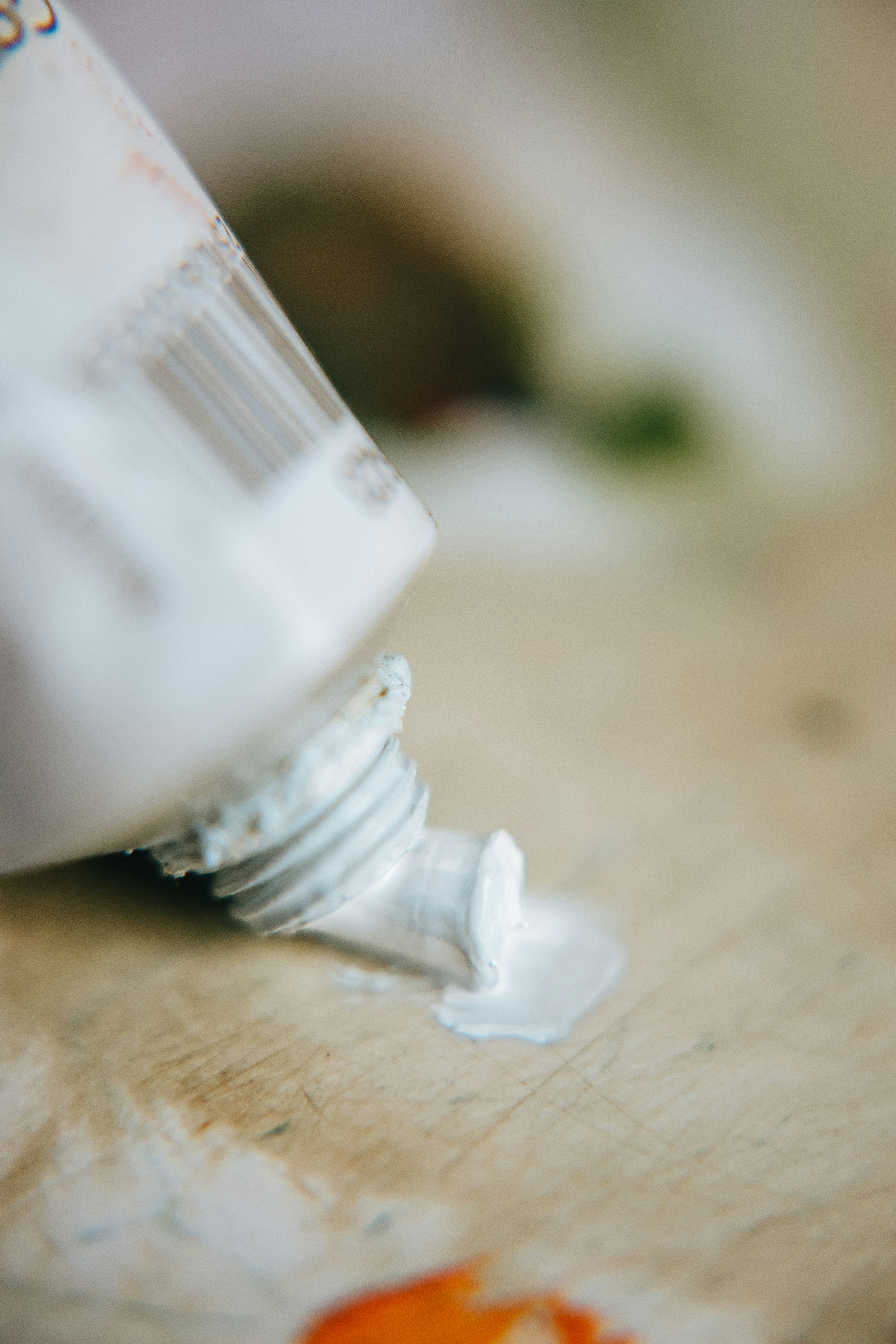 A close up of a tube of toothpaste on a table photo – Free Painting ...