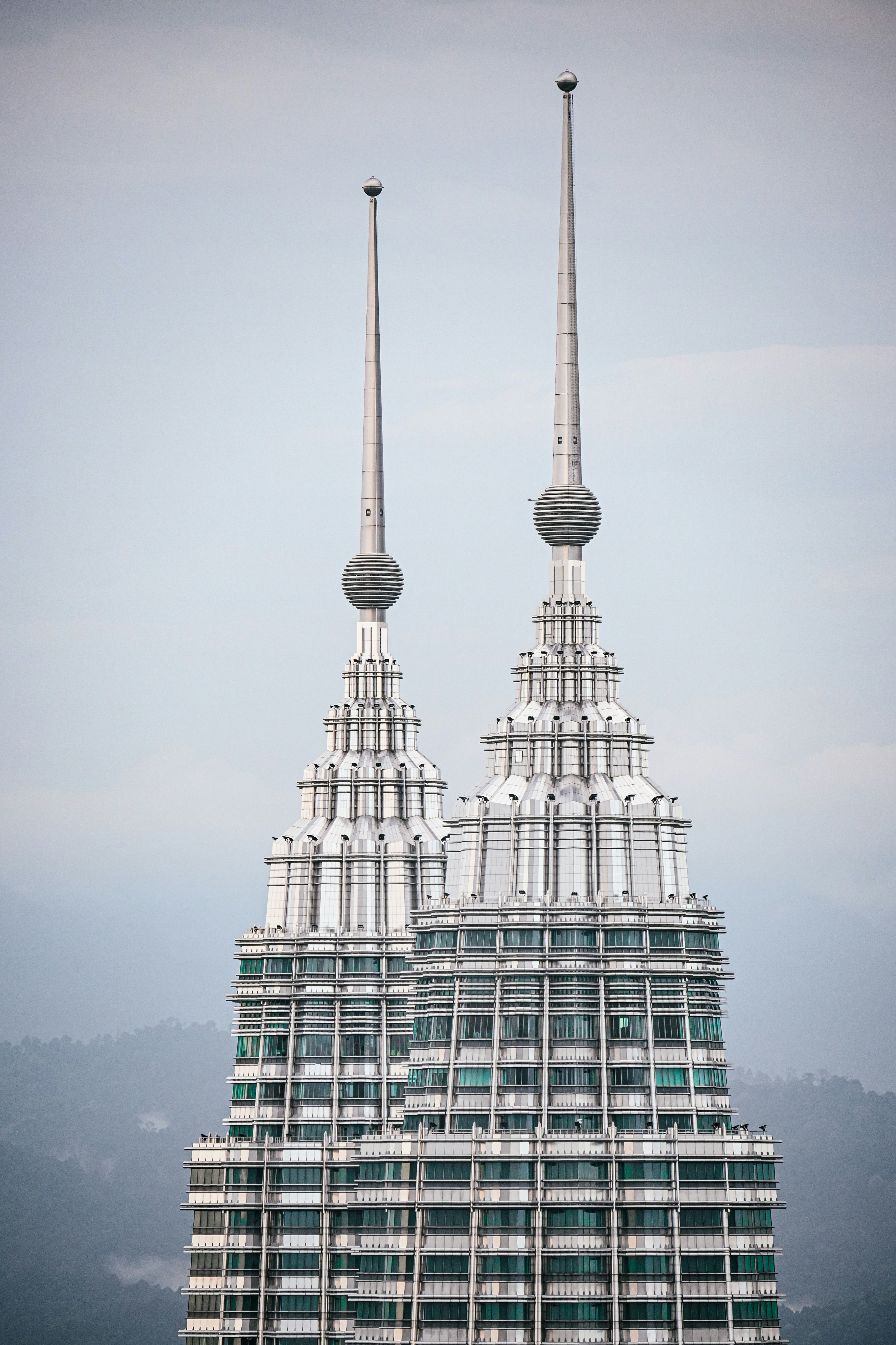 A very tall building with two spires on top of it photo – Free Kuala ...