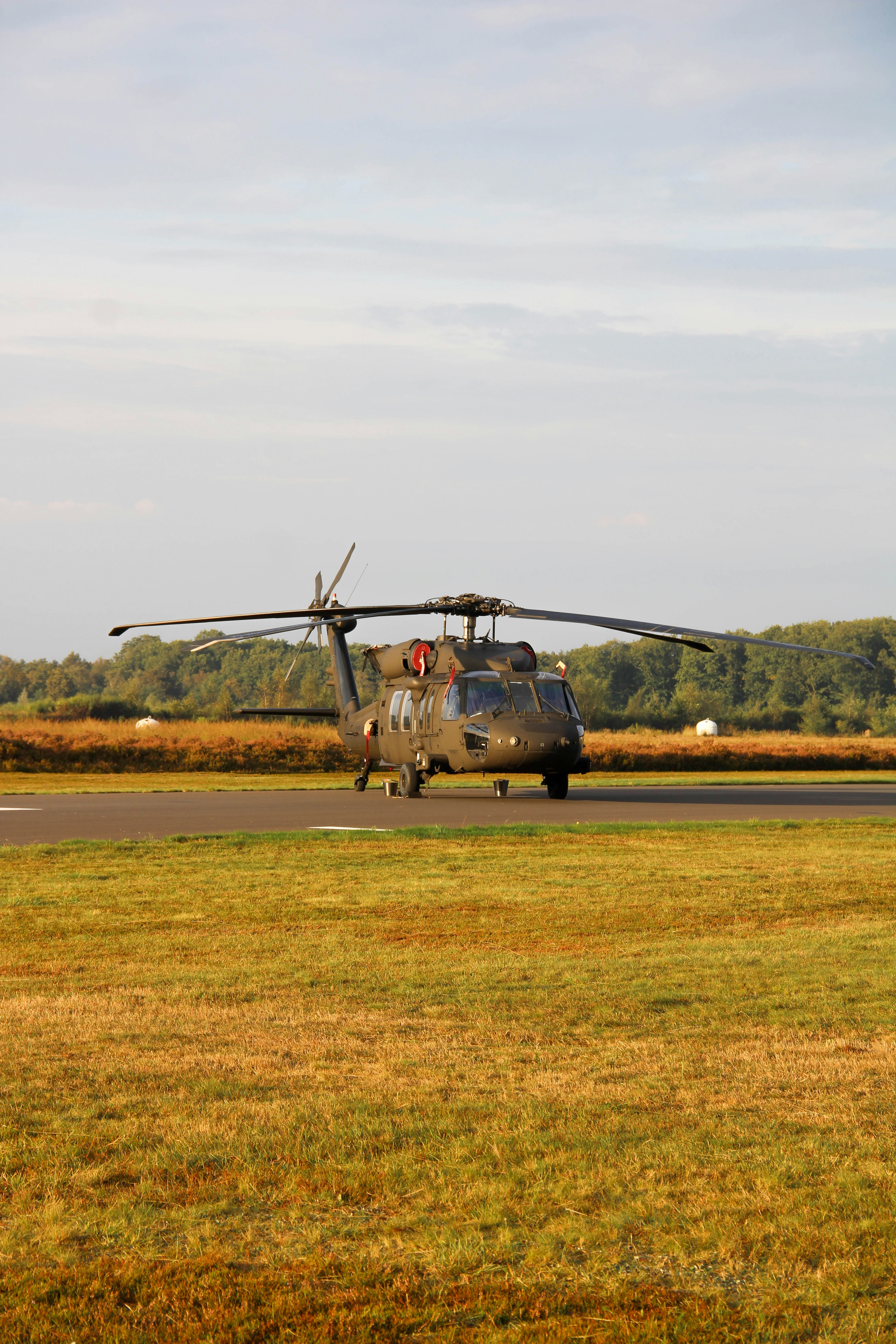 A helicopter sitting on top of an airport runway photo – Free Belgium ...