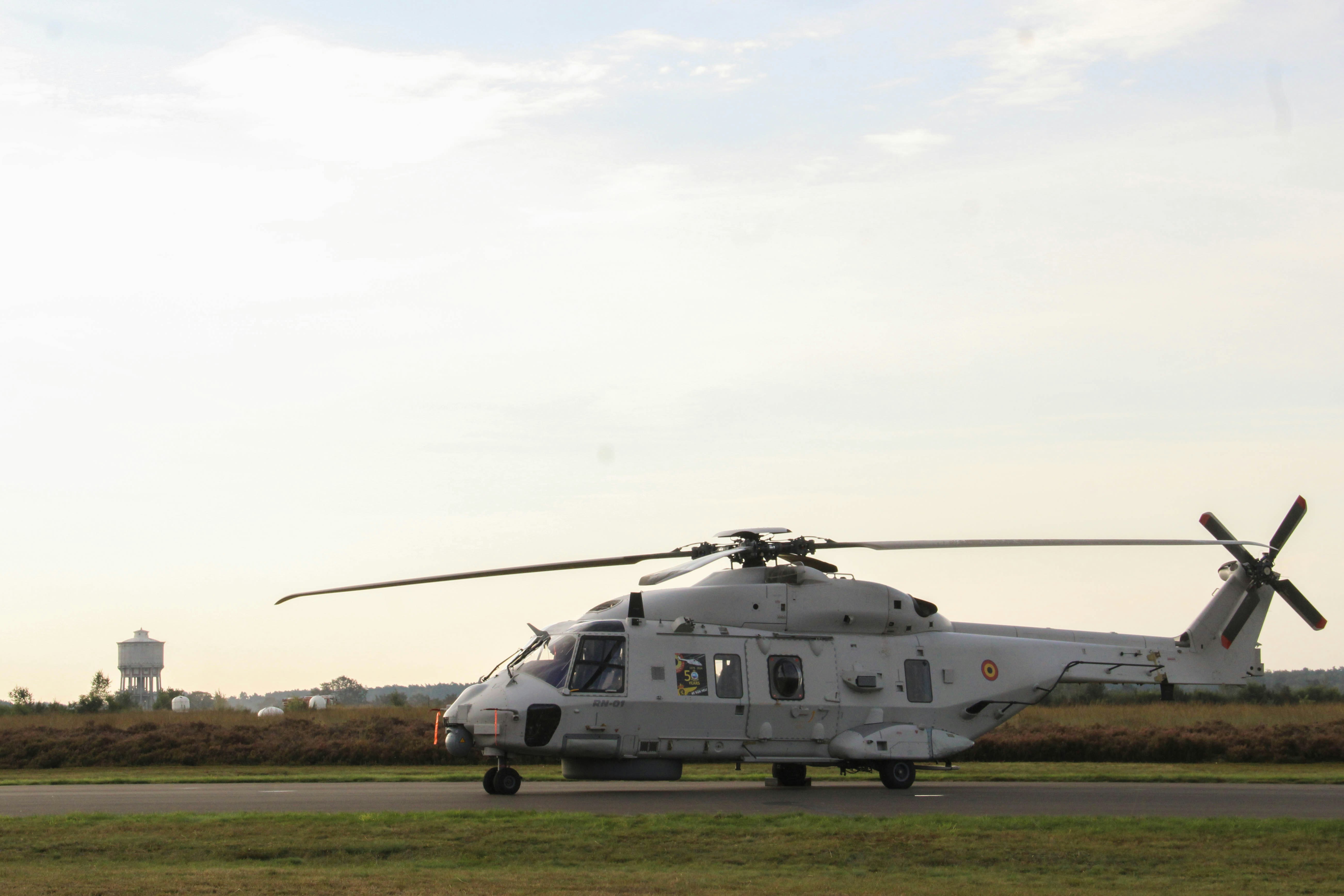 A helicopter sitting on top of an airport runway photo – Free Military ...