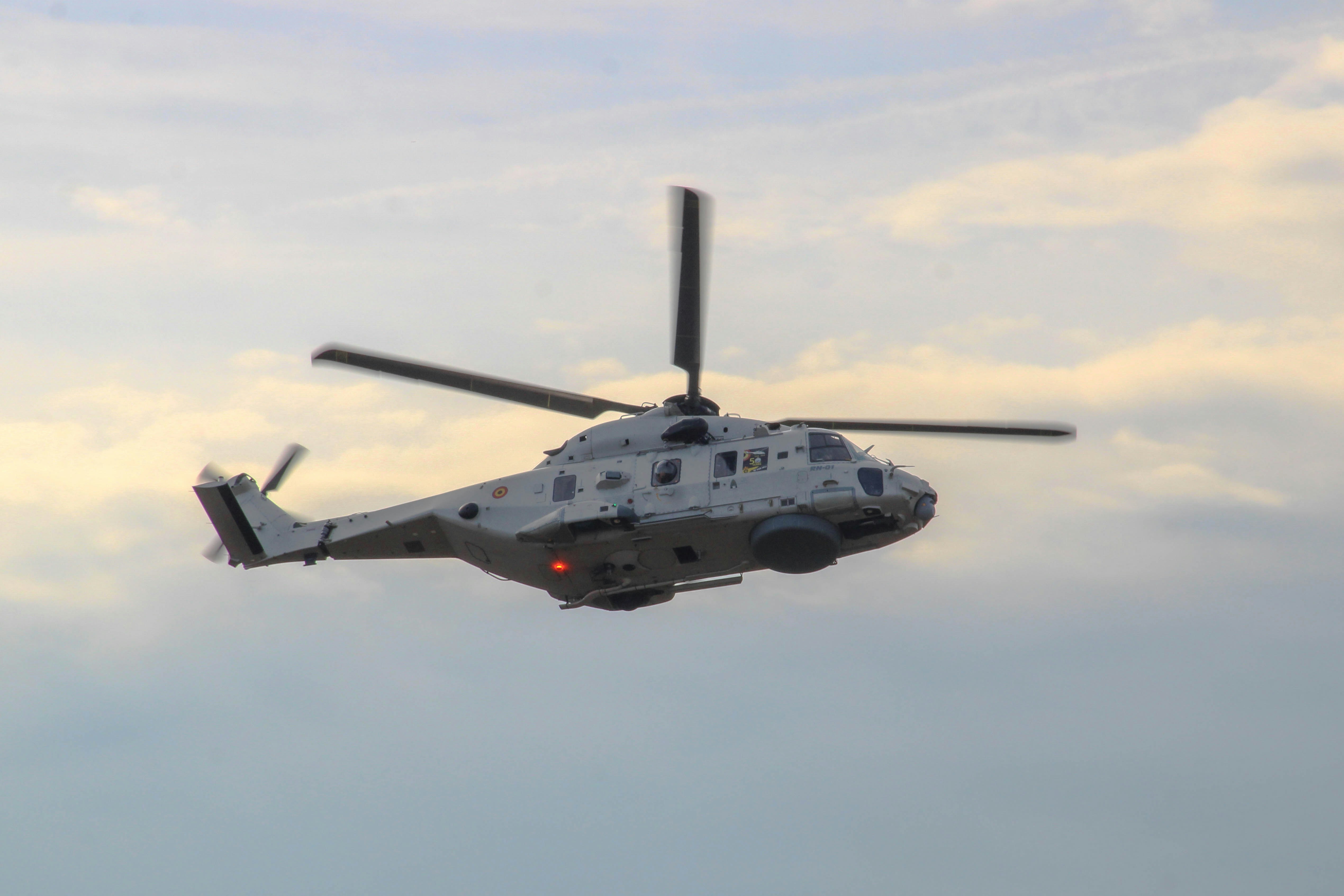 A helicopter flying through a cloudy blue sky photo – Free Military ...