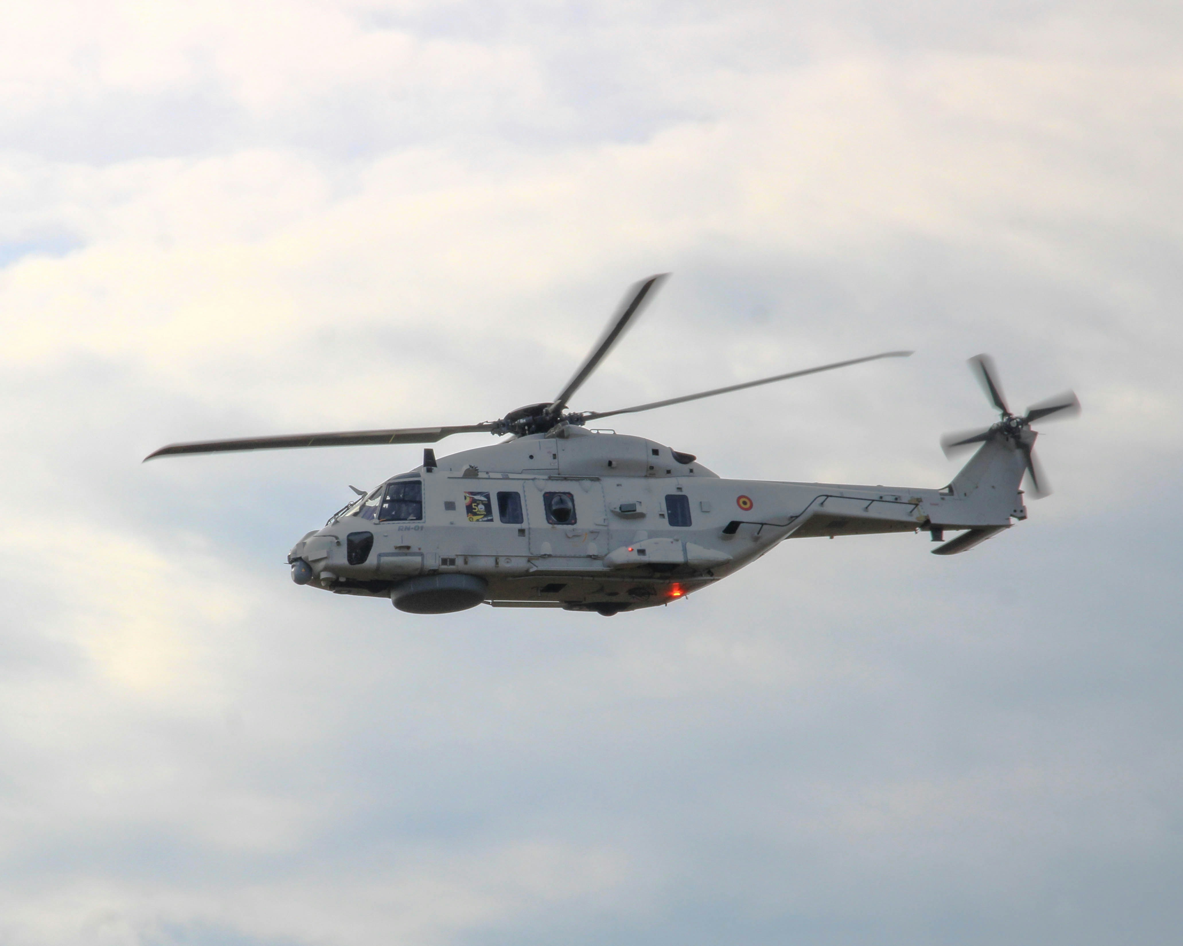 A helicopter flying through a cloudy blue sky photo – Free Military ...