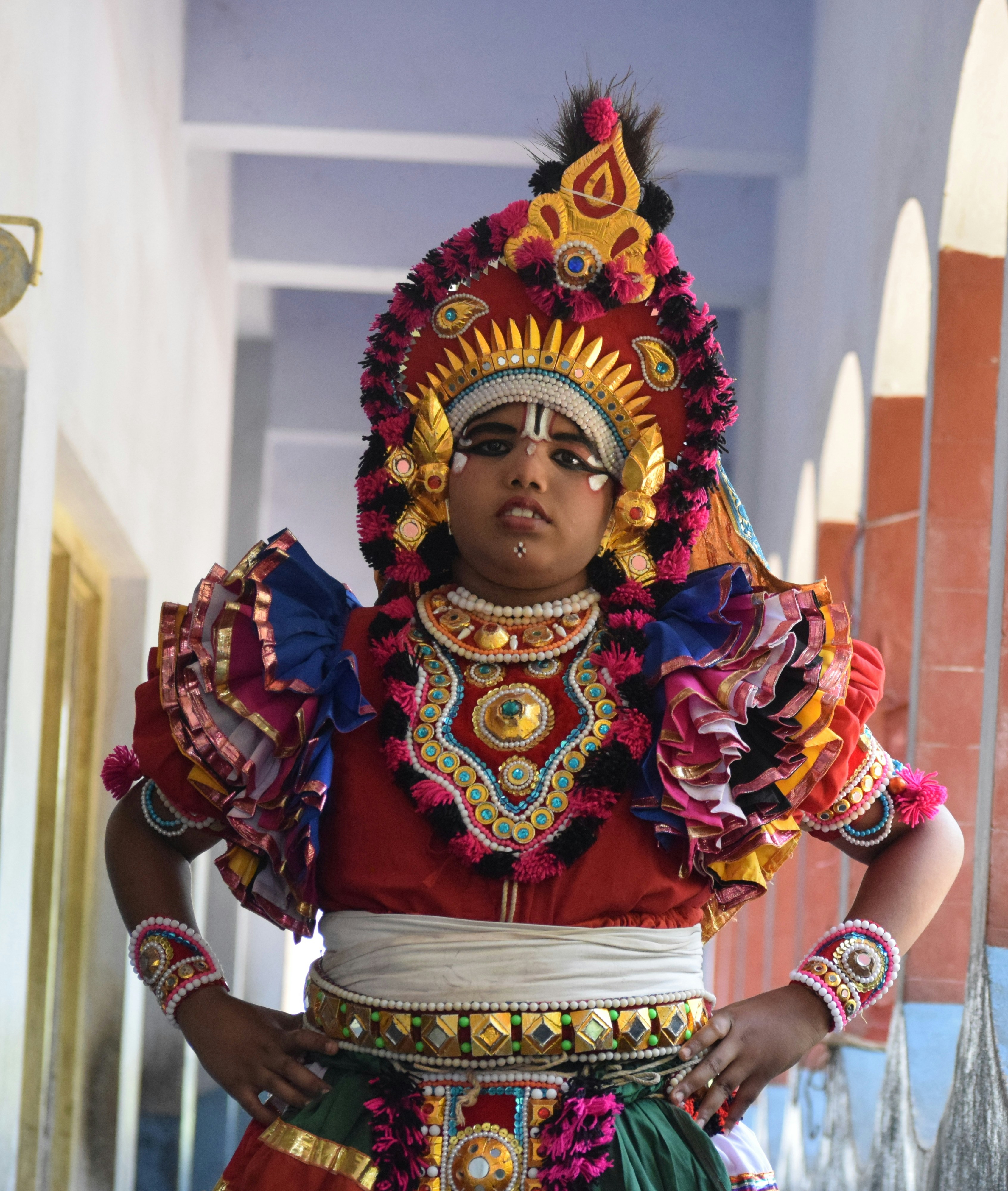 Regalia Under the Arch: A Traditional Dancer in Kaleidoscopic Costume